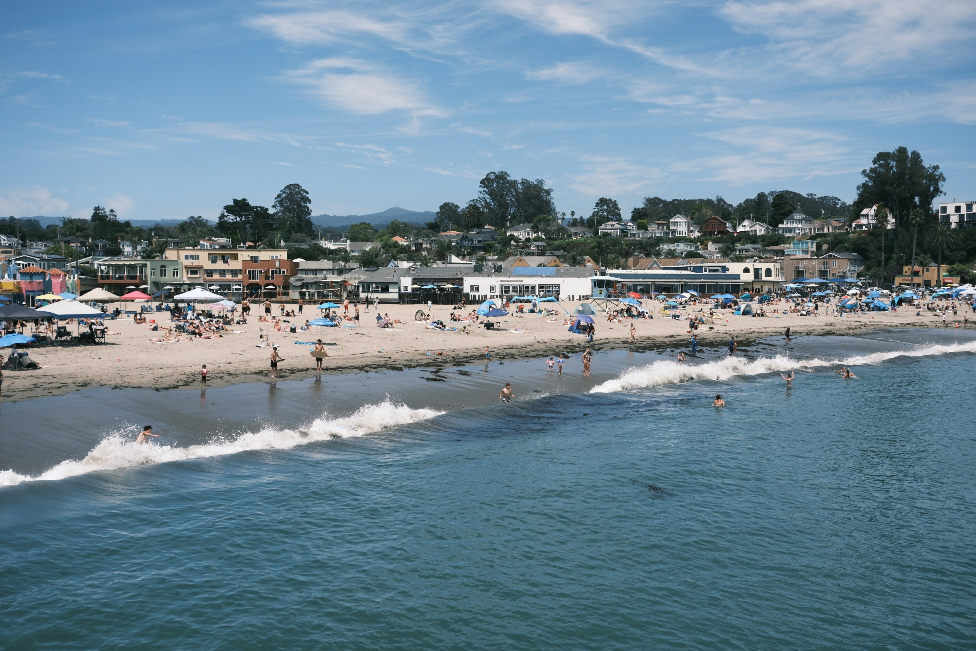 Coastal Haven: Beachfront Cityscape with Surf and Umbrella Rhythm