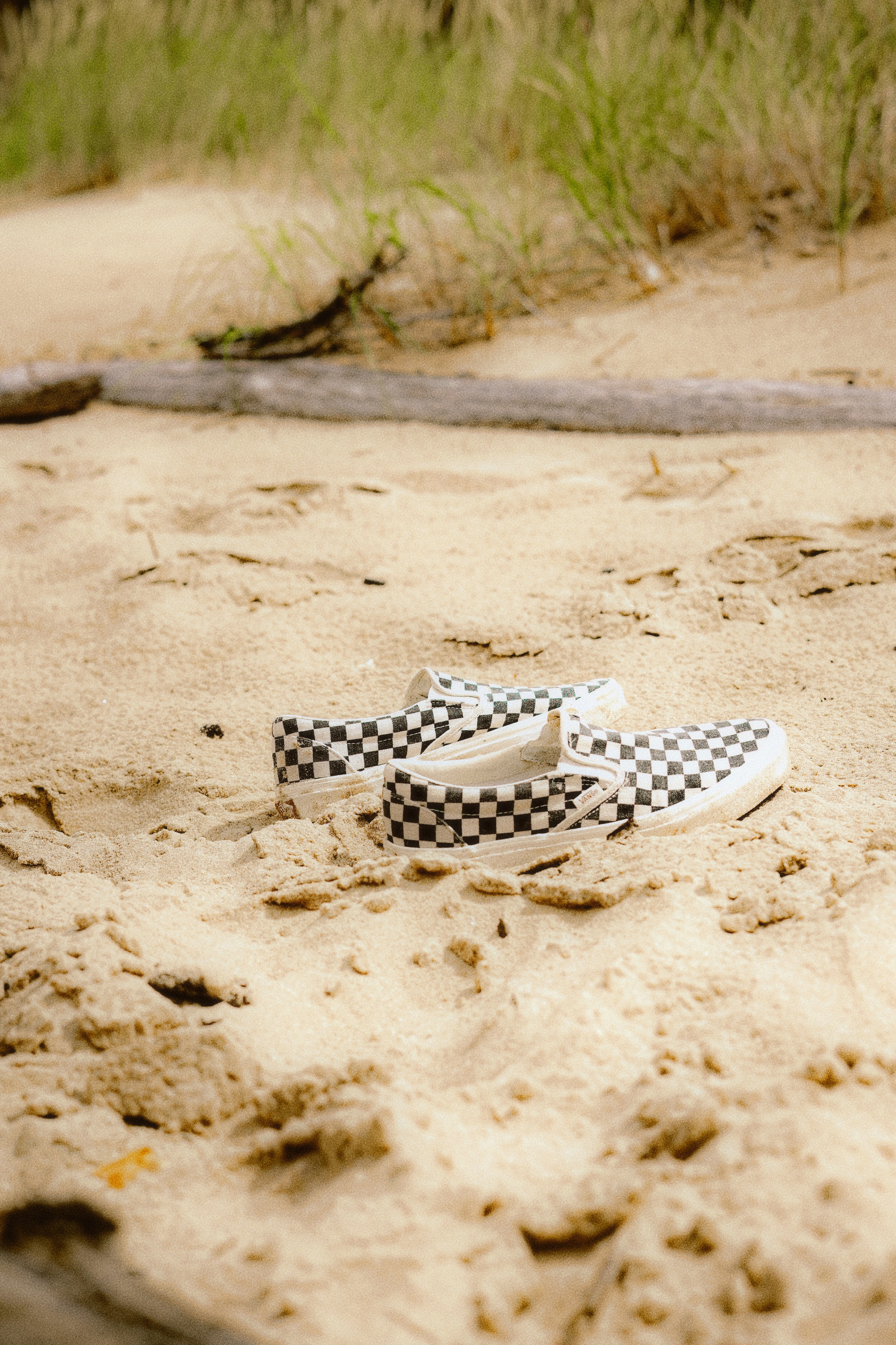 Checkerboard Shoes on Sunlit Sand