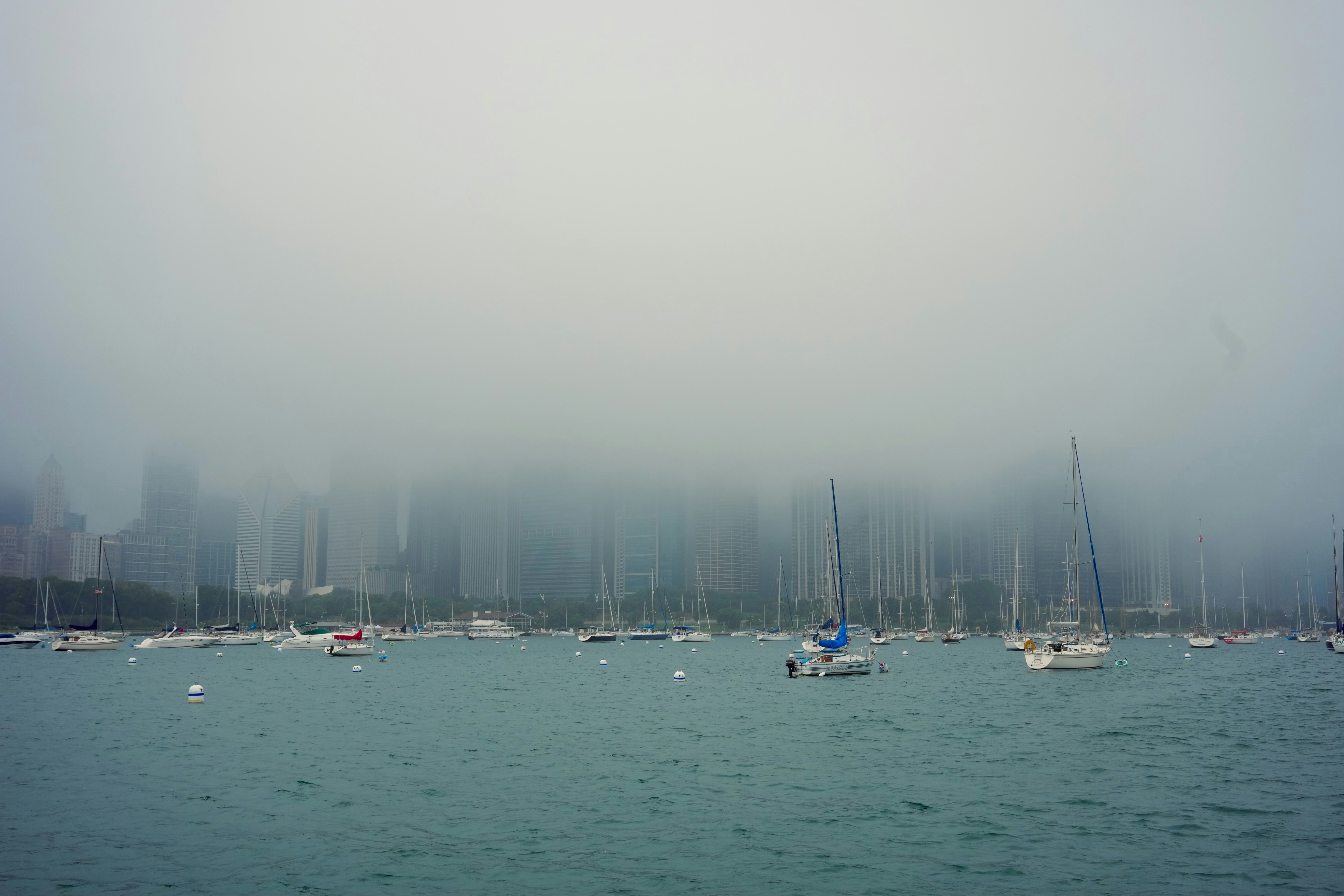 Low‑Fog Marina: Boats Emergent Under a Misty Skyline