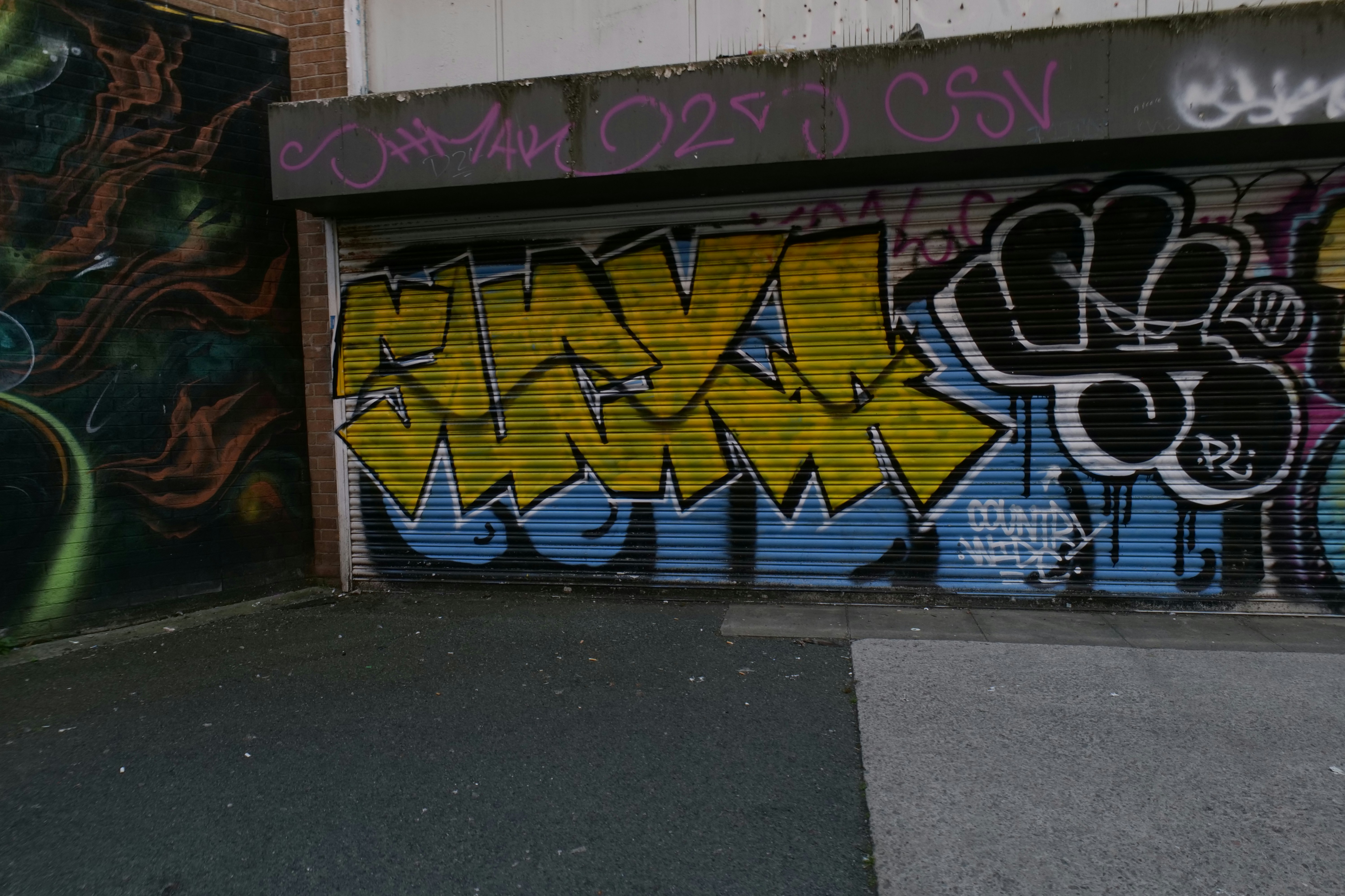 Yellow Graffiti Tag Anchored by Dark Backdrop