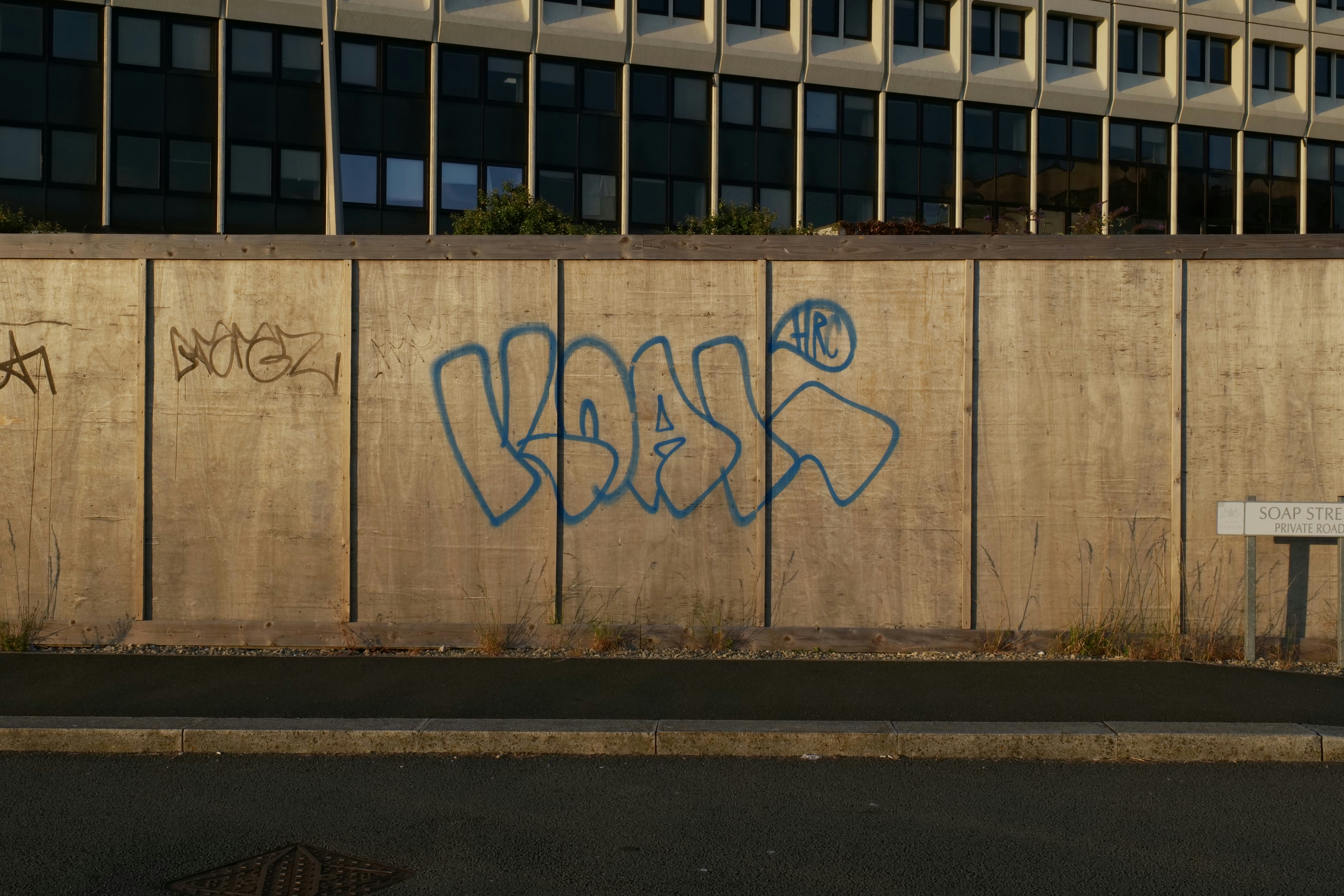 Graffiti Portrait on a Concrete Barrier under Office Windows