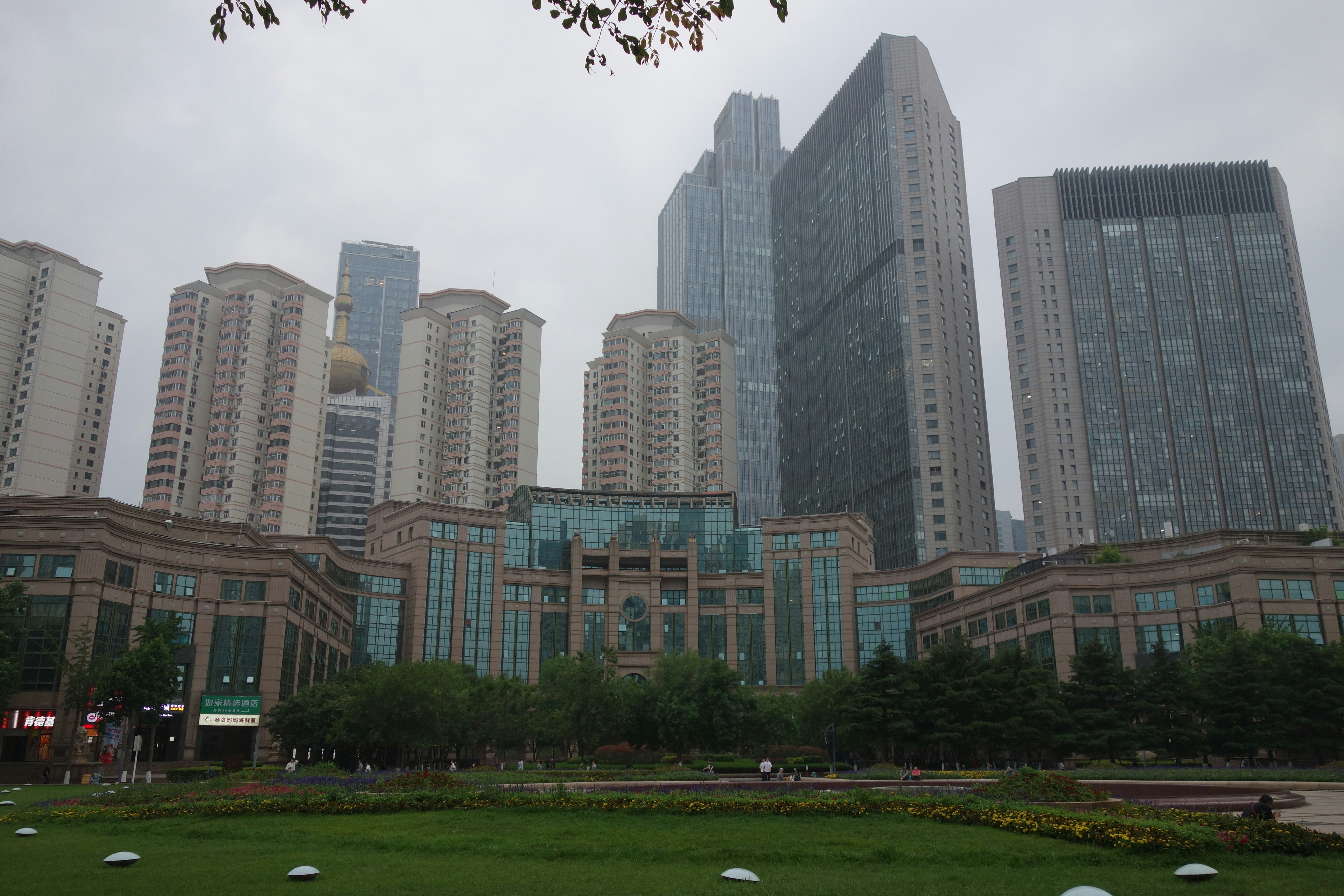 Urban Monoliths: Skyward Glass and Green Forecourt