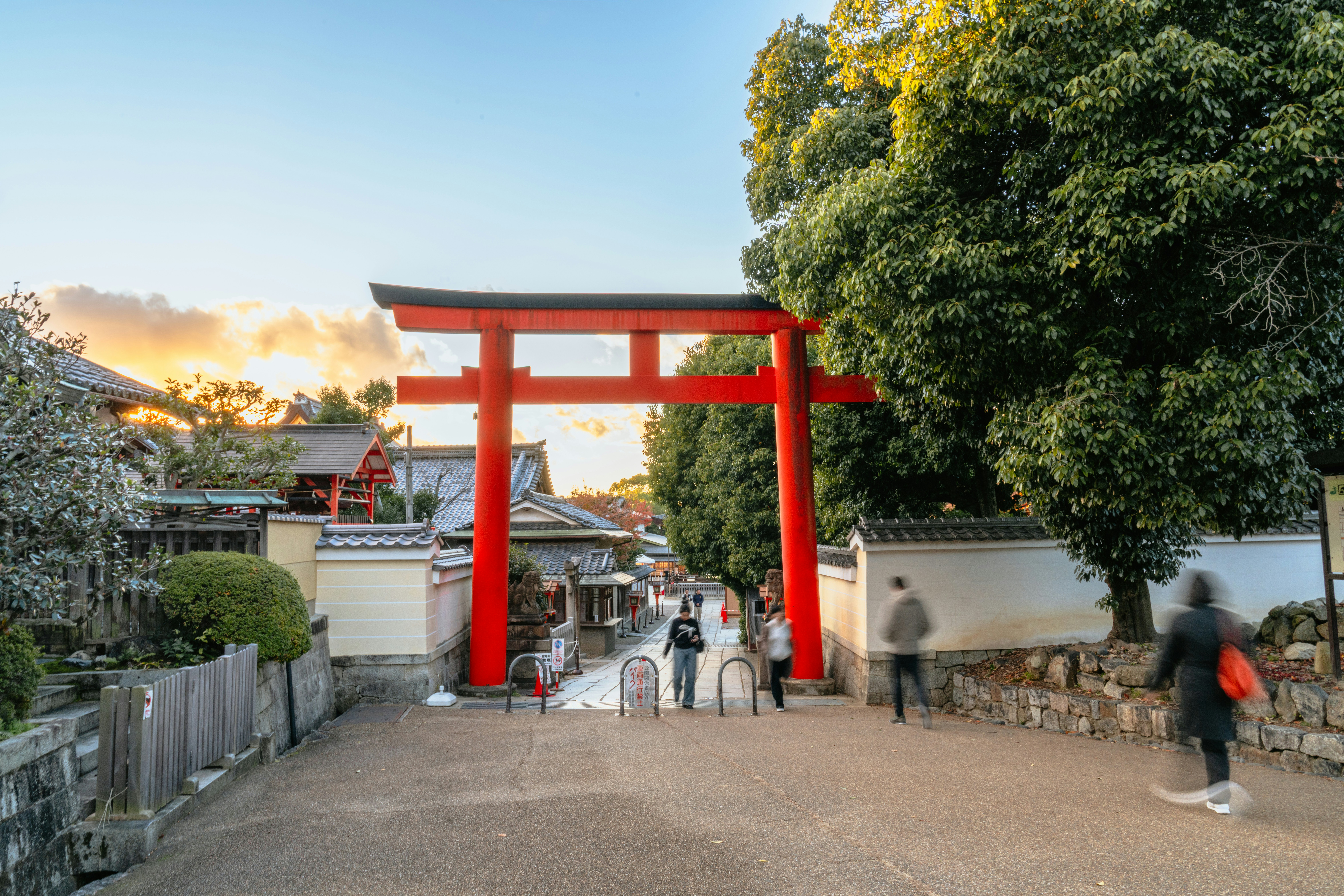Red Torii Gate Framing a Quiet Temple Entrance at Dusk