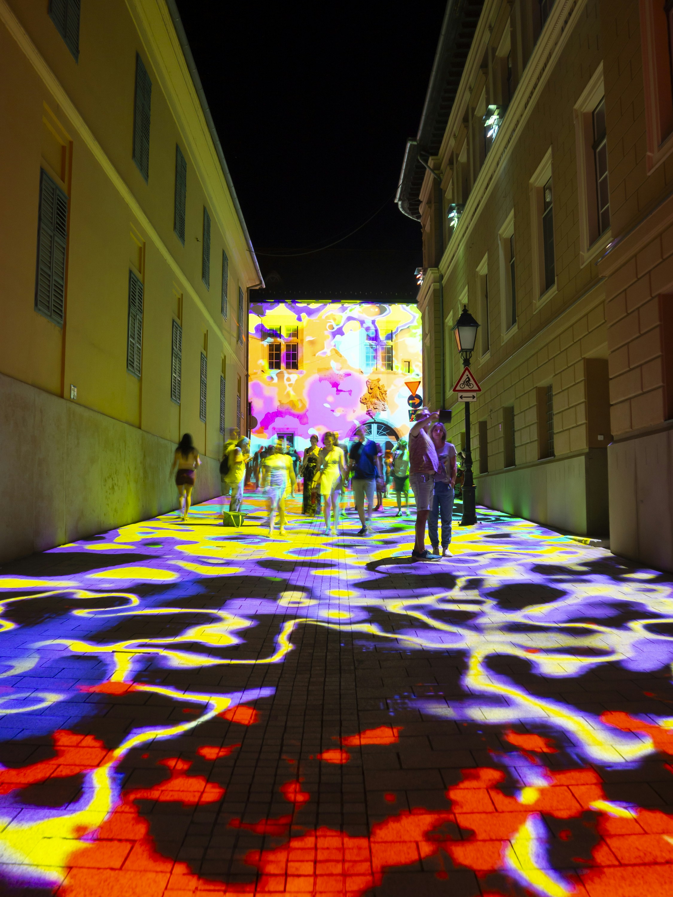 Neon Alleyway: A Night of Dancing Colors on a Projected Path