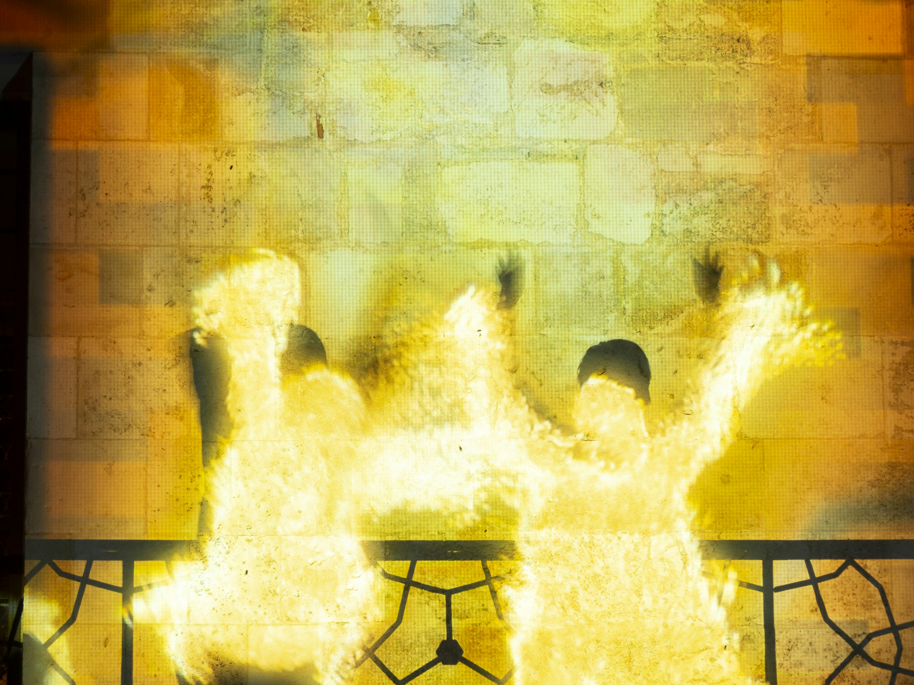 Electric Glow: Hands Raised in a Fiery Greeting