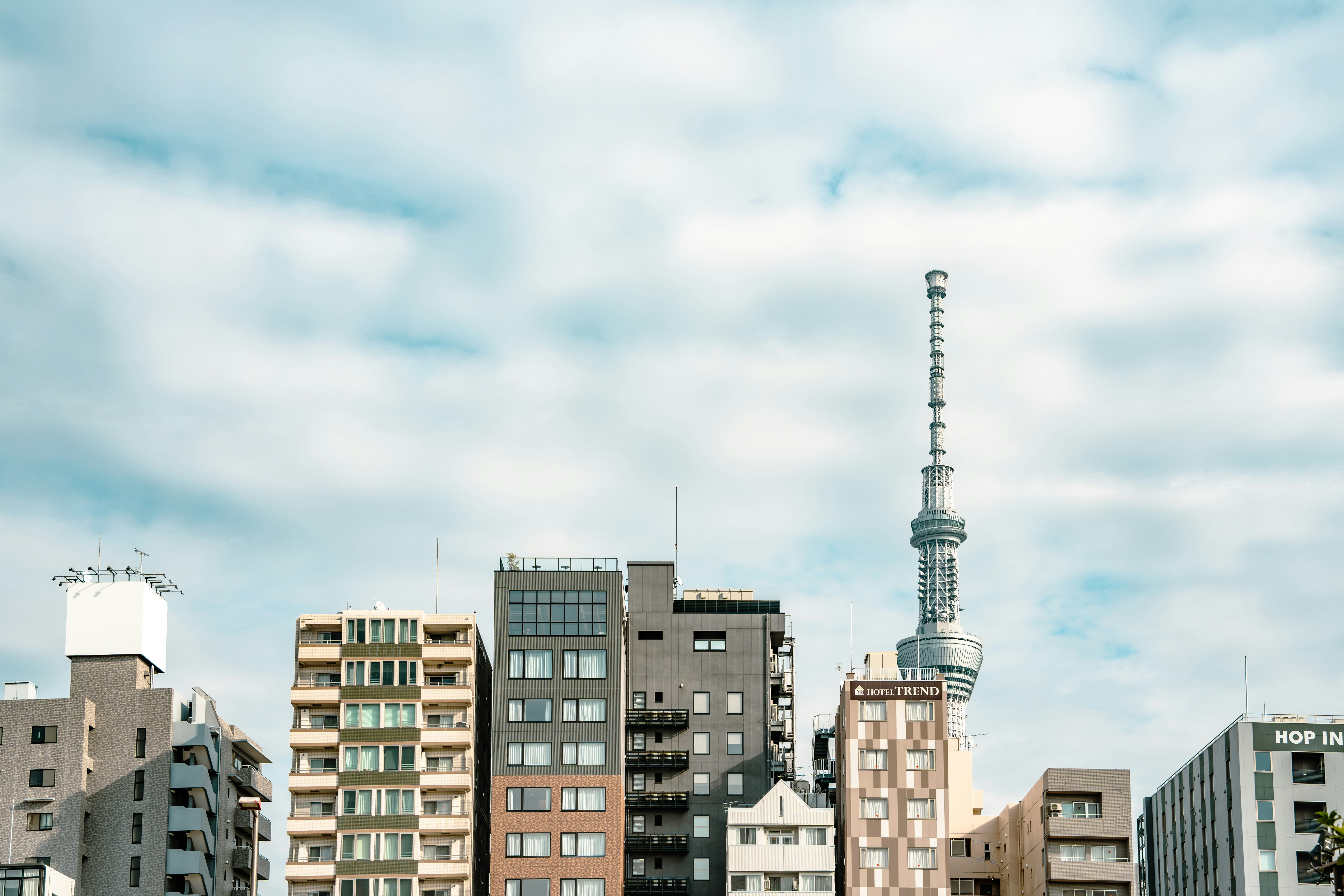City Skyline Uphill: Towering Antenna and Row of Buildings