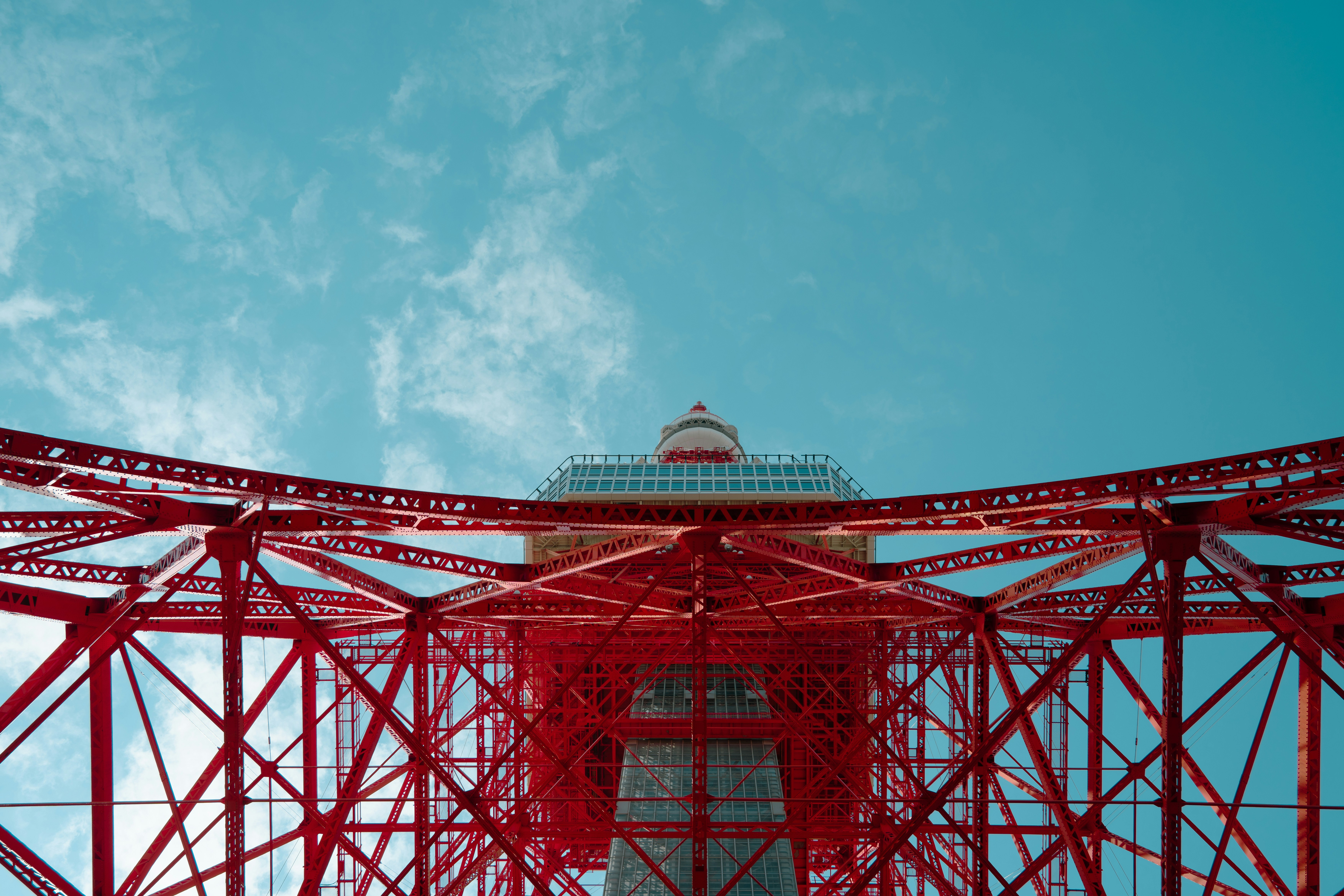 Crimson Lattice: Upward View Through a Red Steel Truss