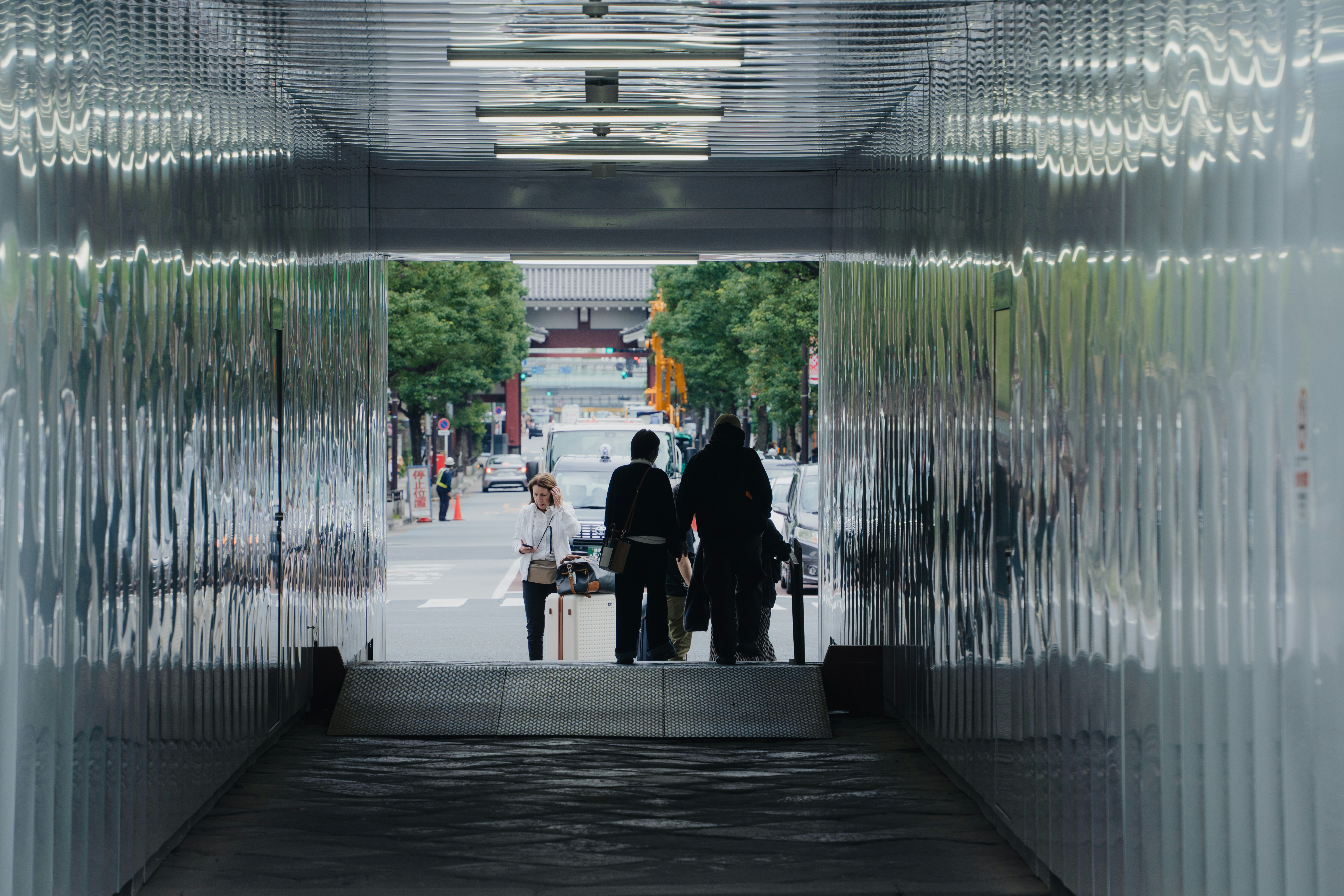 Crossing Light: People Emergence from a Reflective Tunnel