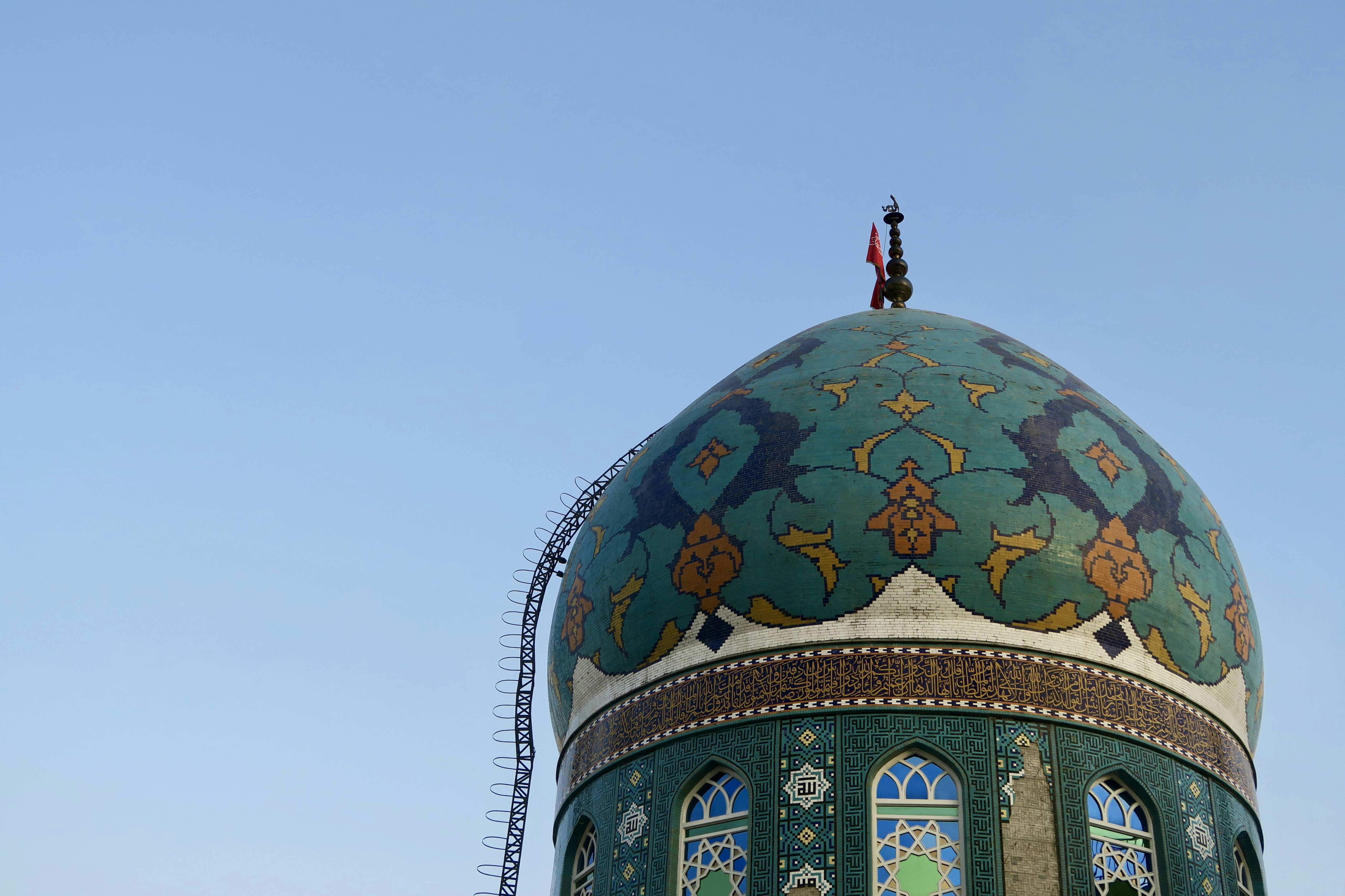 Turquoise Dome of a Historic Structure Reaching Toward a Clear Sky