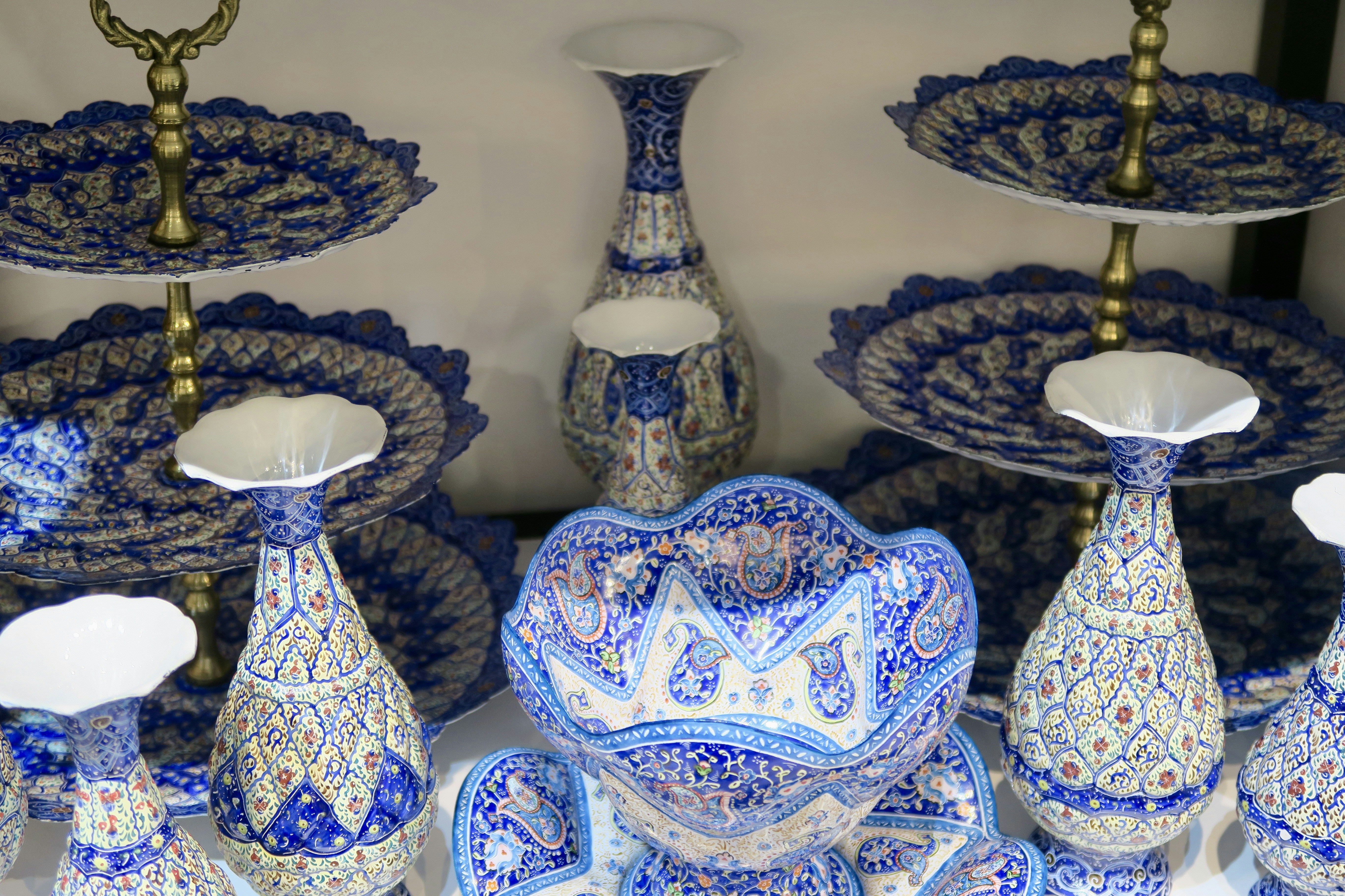 Blue and White Ceramic Display: Intricate Porcelain Patterns in a Shelf Arrangement