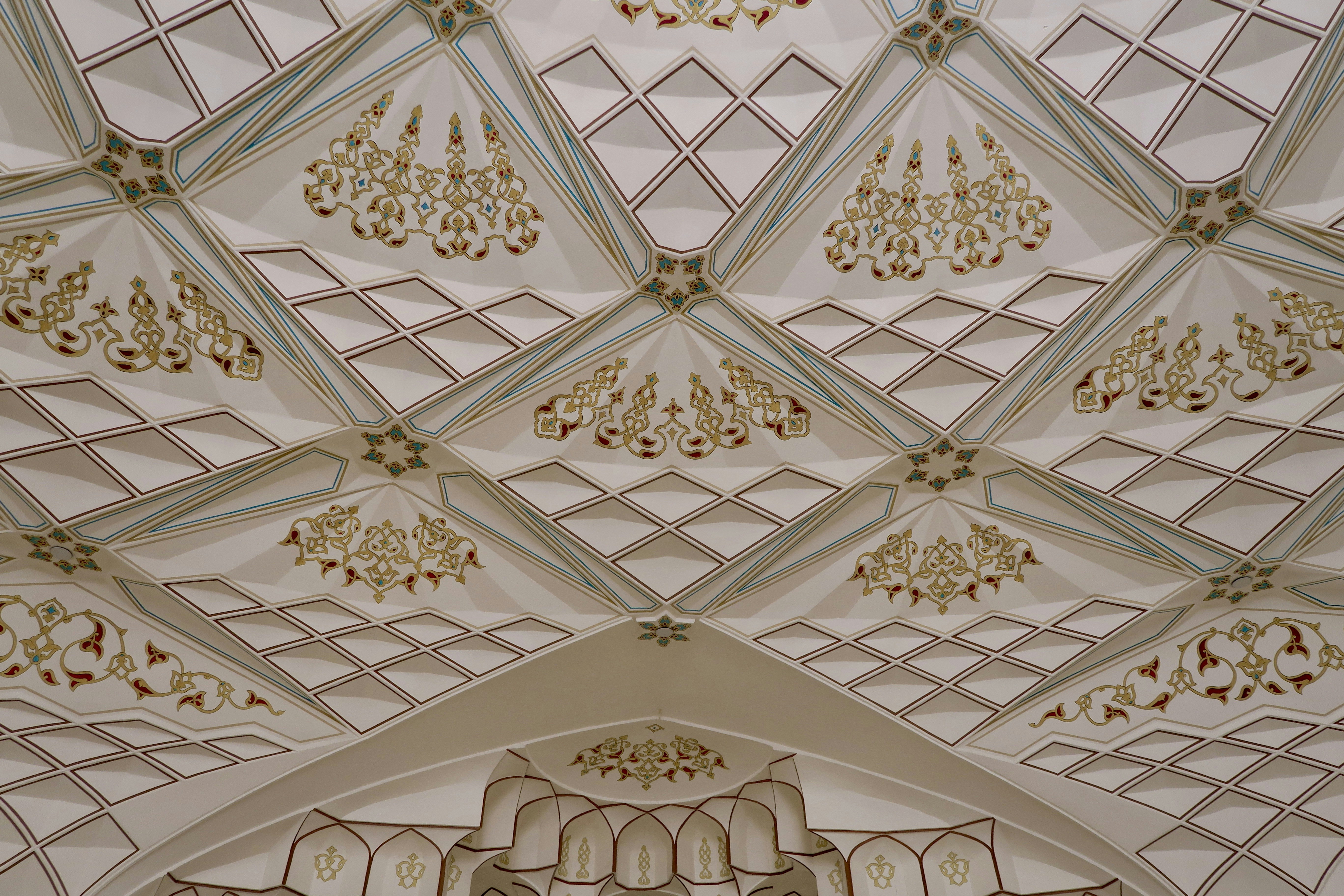 Ornate Coffered Ceiling: symmetrical gold embellishments and arches