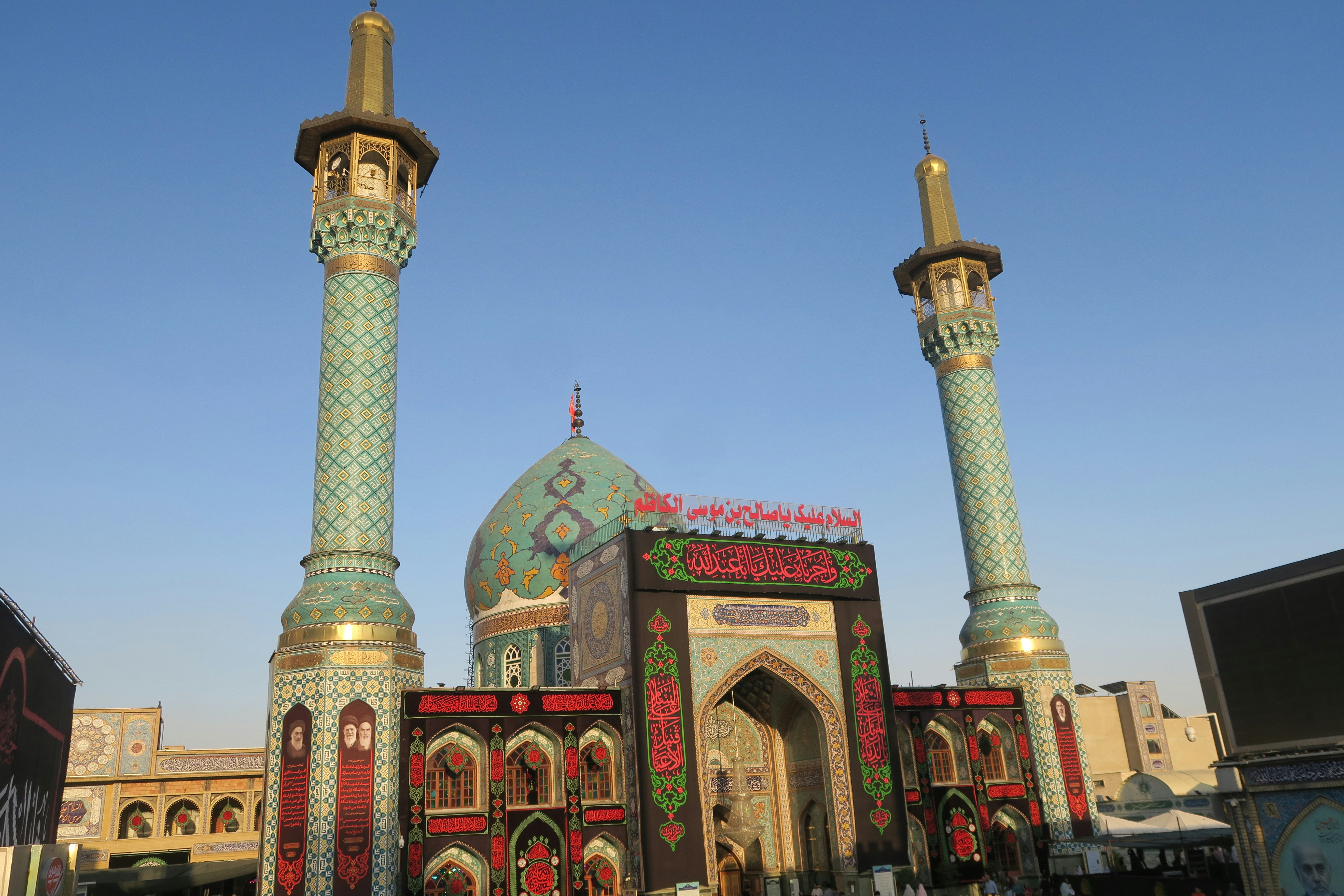 Ornate Shiite Shrine Framed by Twin Minarets under a Clear Sky