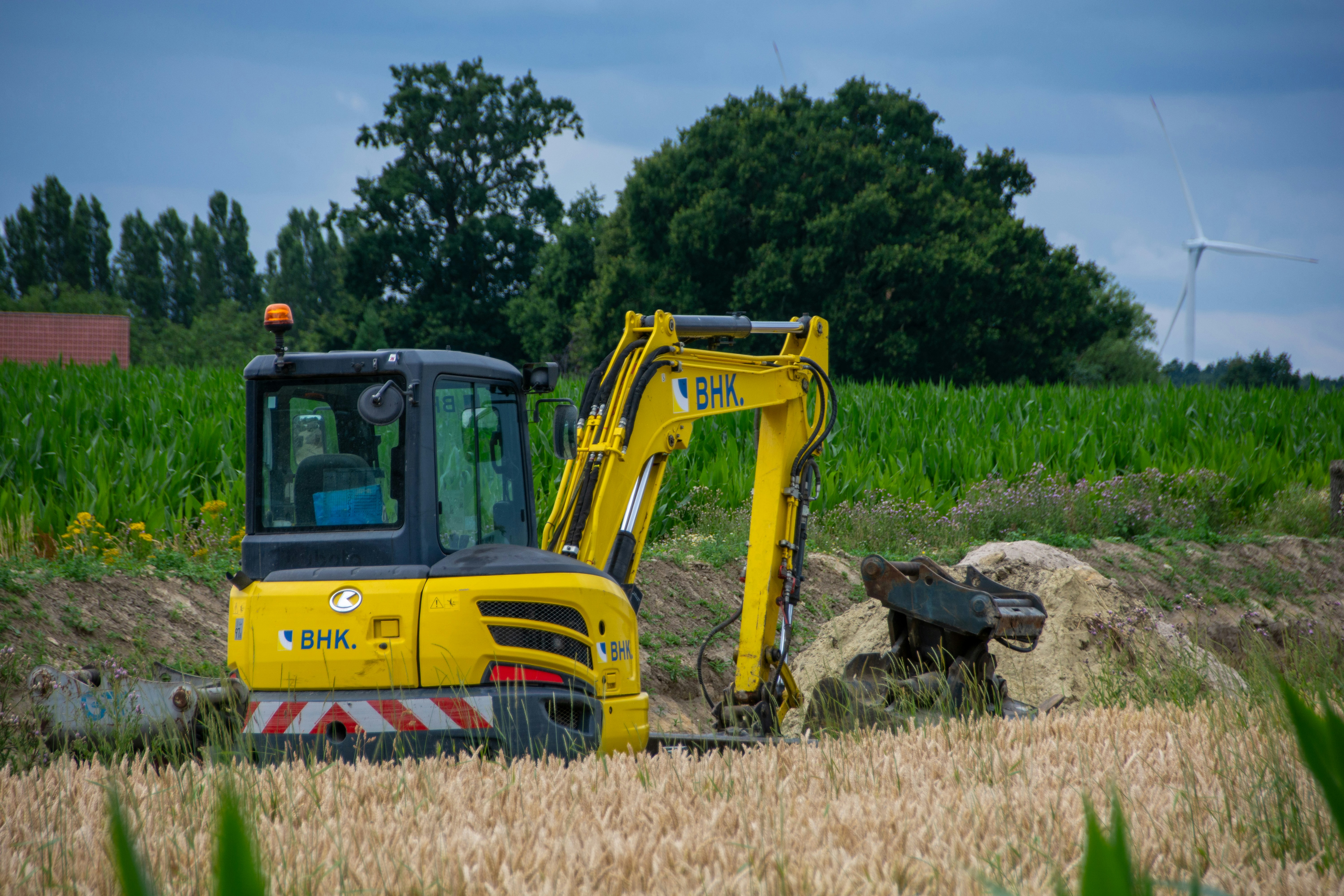 Yellow Excavator at Work: Dust, Dirt, and Determination