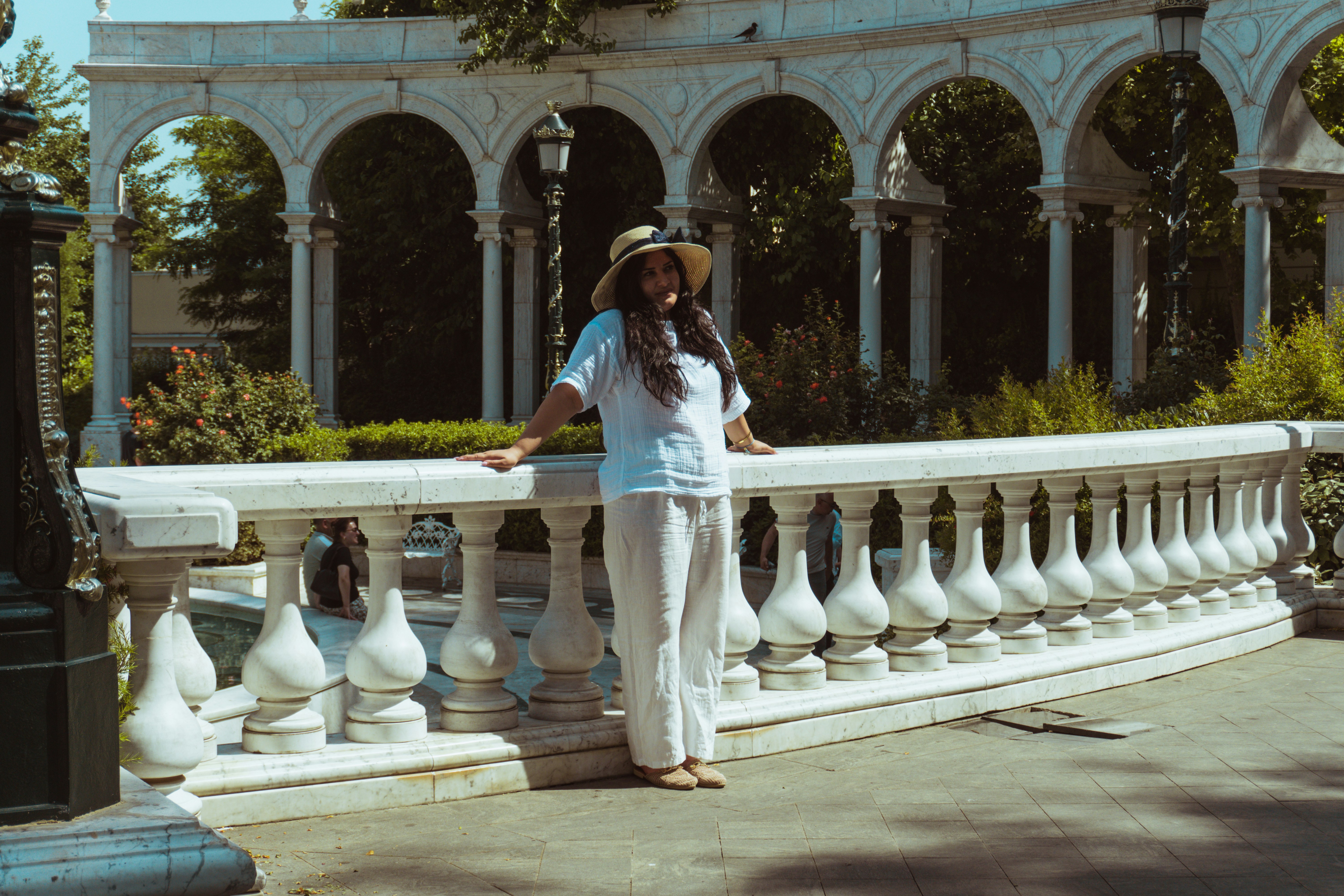 Sunlit Terrace Portrait beneath Classical Arches