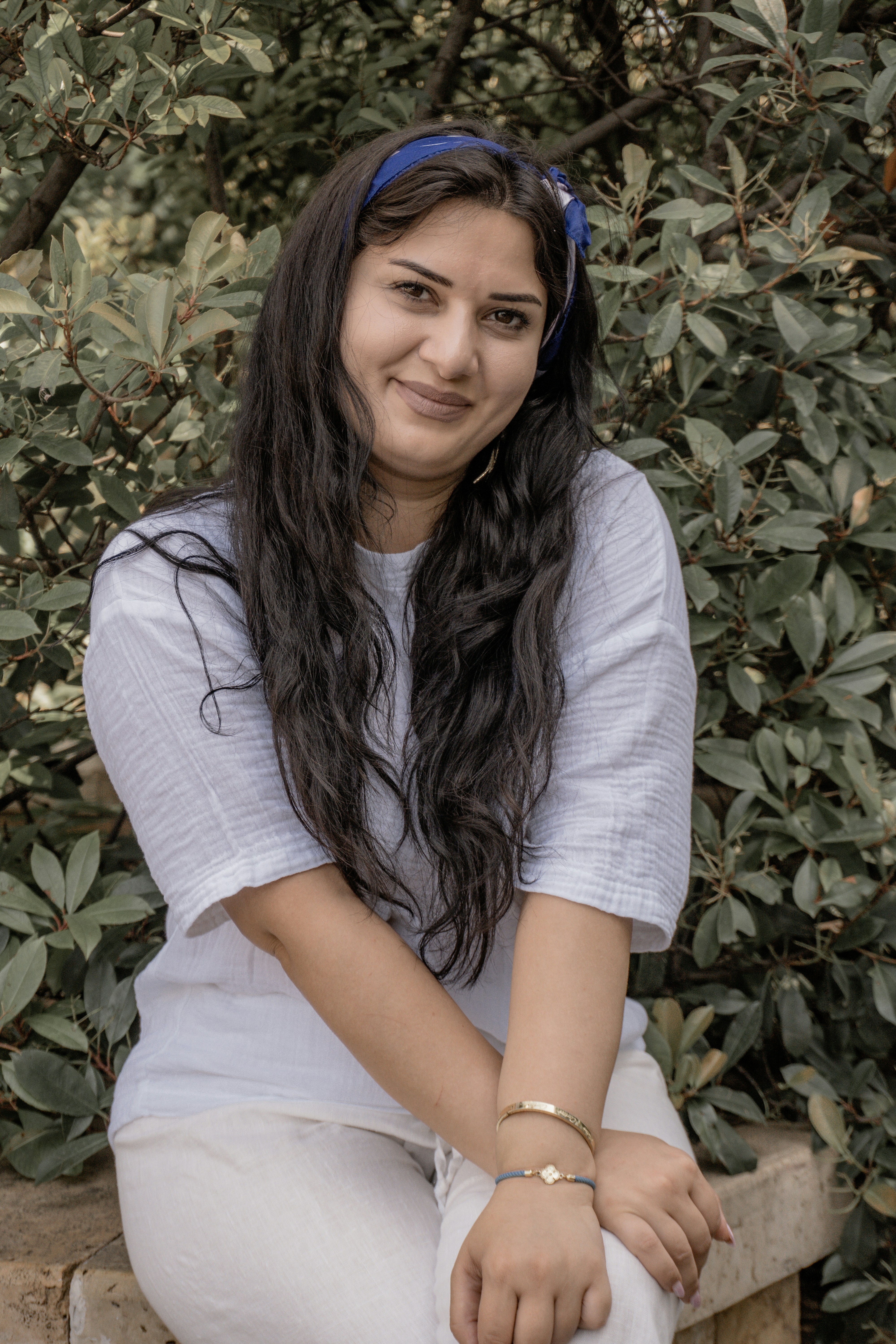 Soft smile in a sunlit garden: portrait of calm confidence