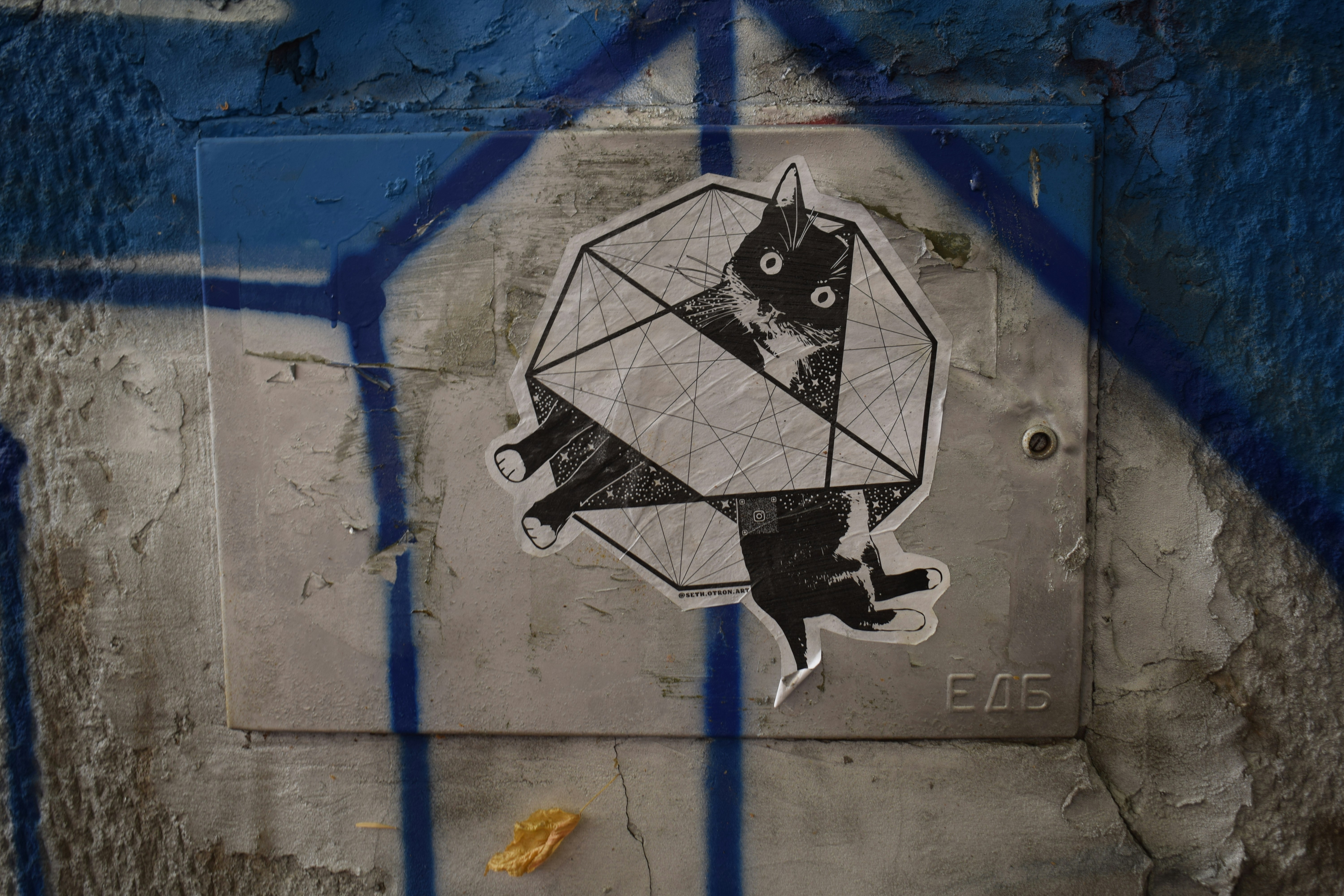 Monstrous Origami Cat Adrift on a Crumbling Wall