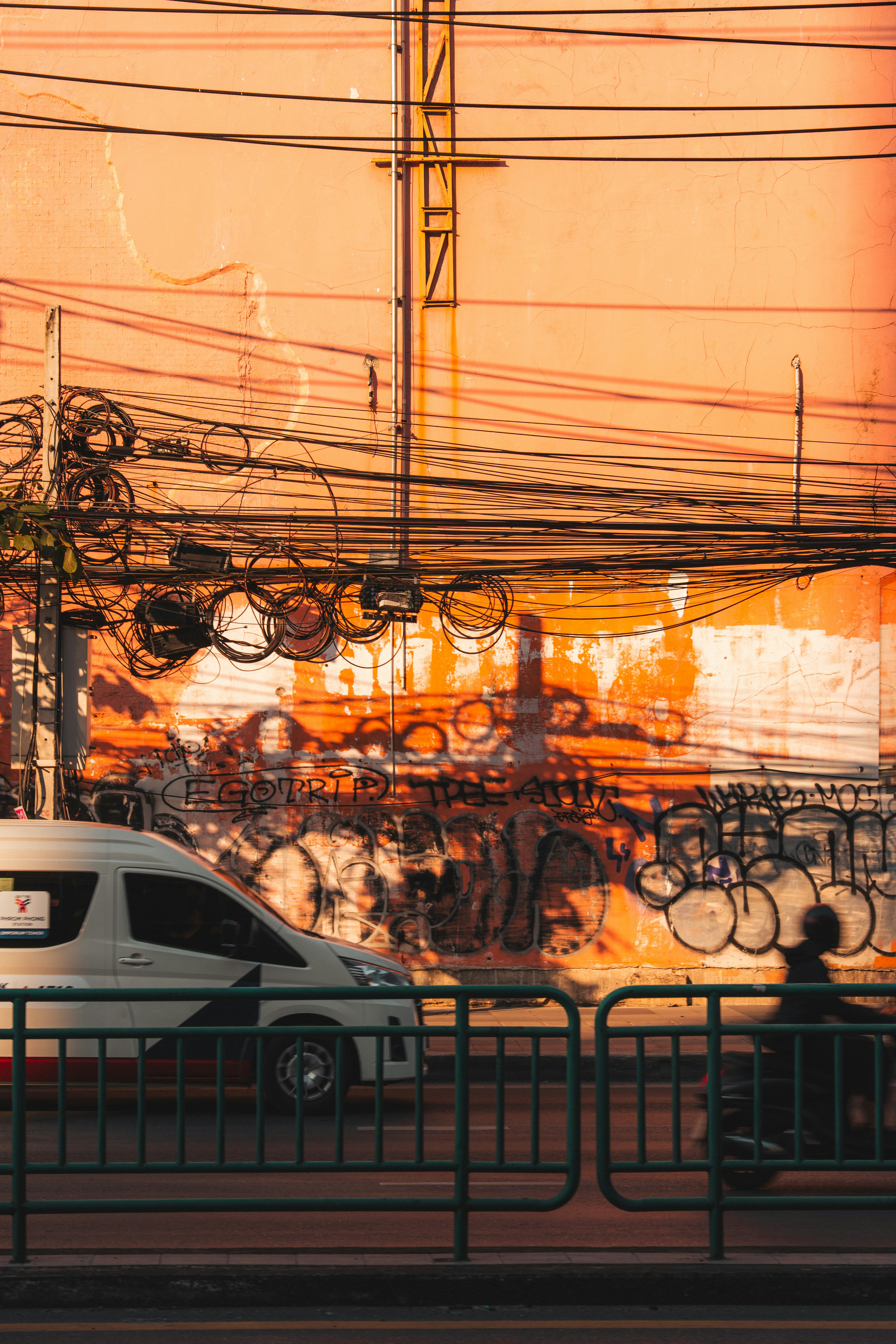 Graffiti Canvas at Dusk: A Street Scene Wrapped in Wires