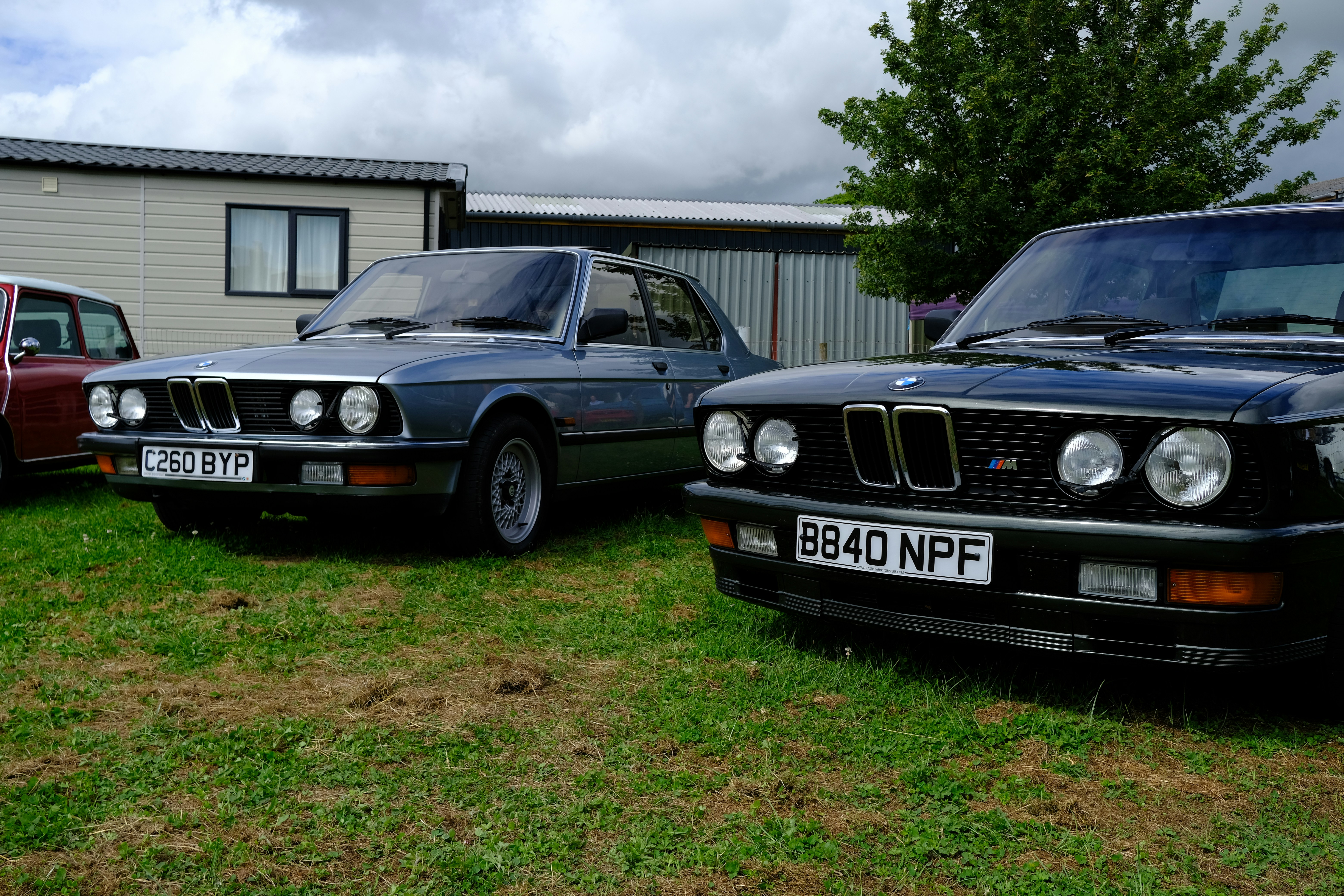 Two Classic Sedans Resting in a Quiet Lot