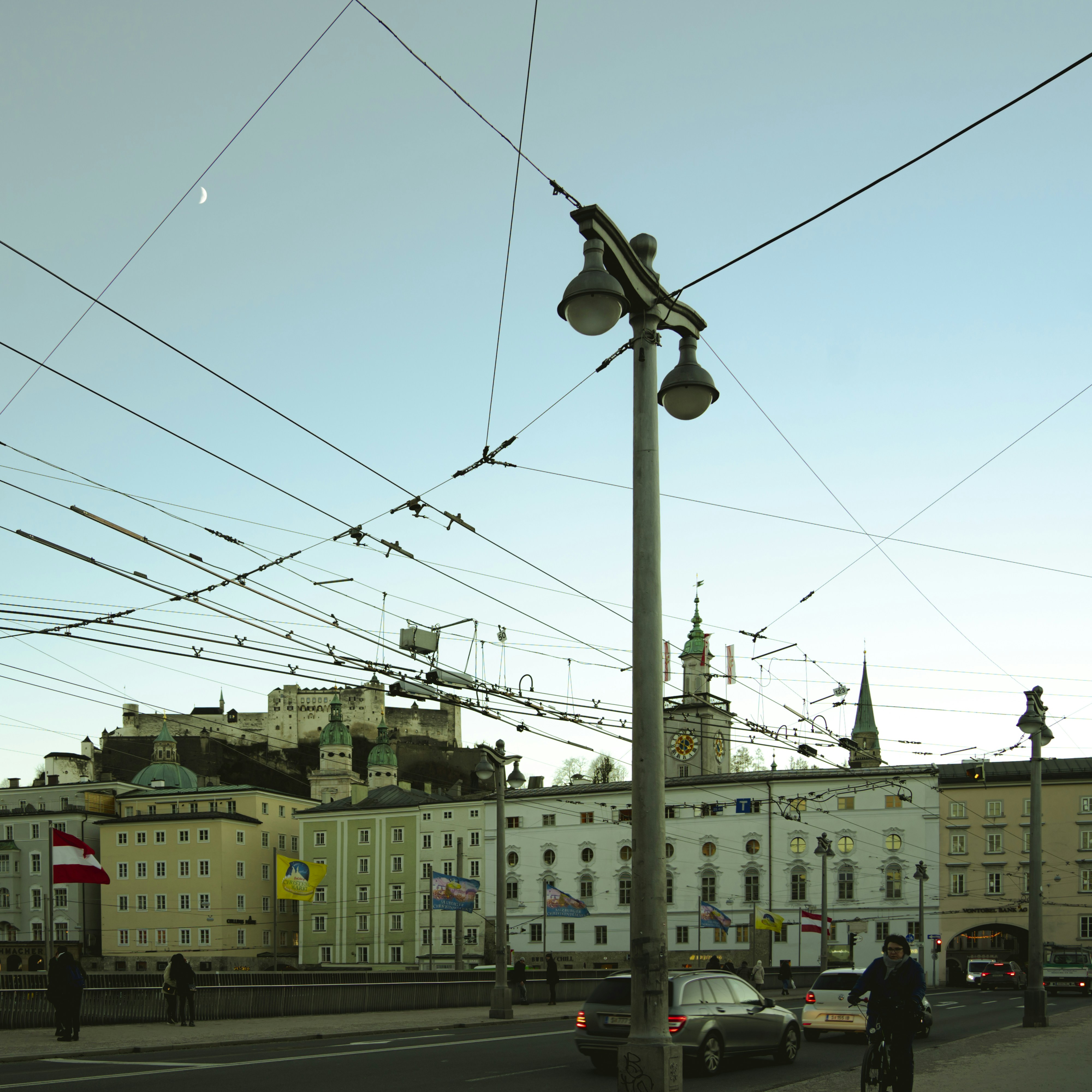 Rope-and-Lamp Street Crossing Over a Historic Cityscape