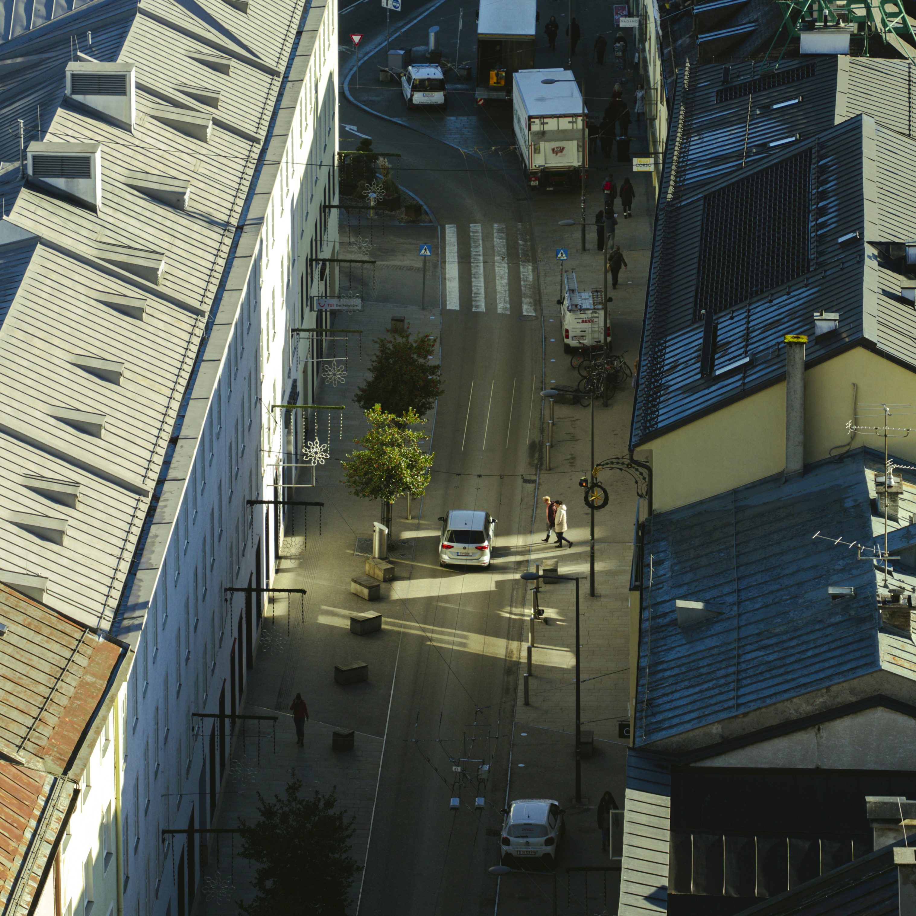 Urban Canyon: A Quiet Street Between Sloped Rooflines