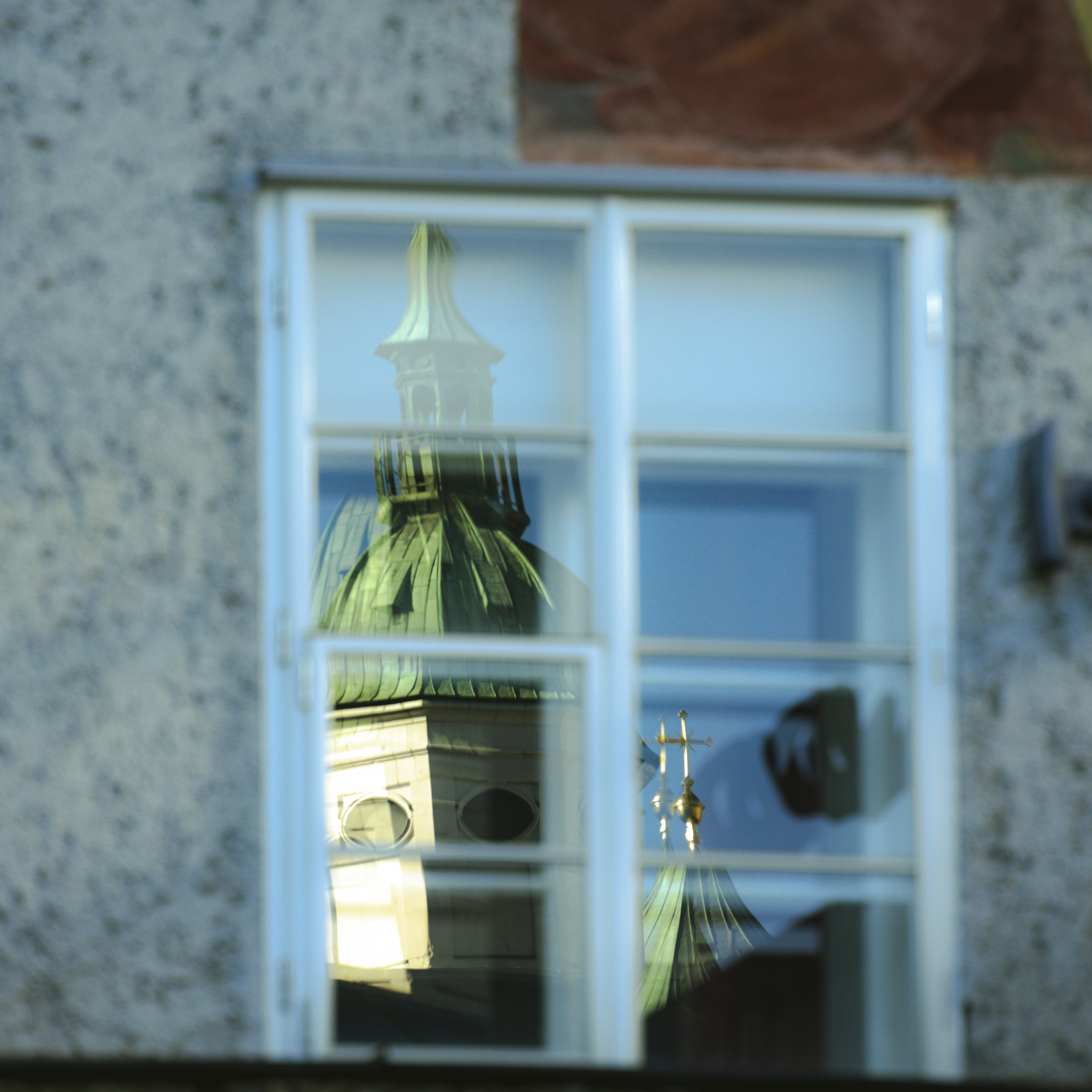  reflections through a divided window: church domes and spire