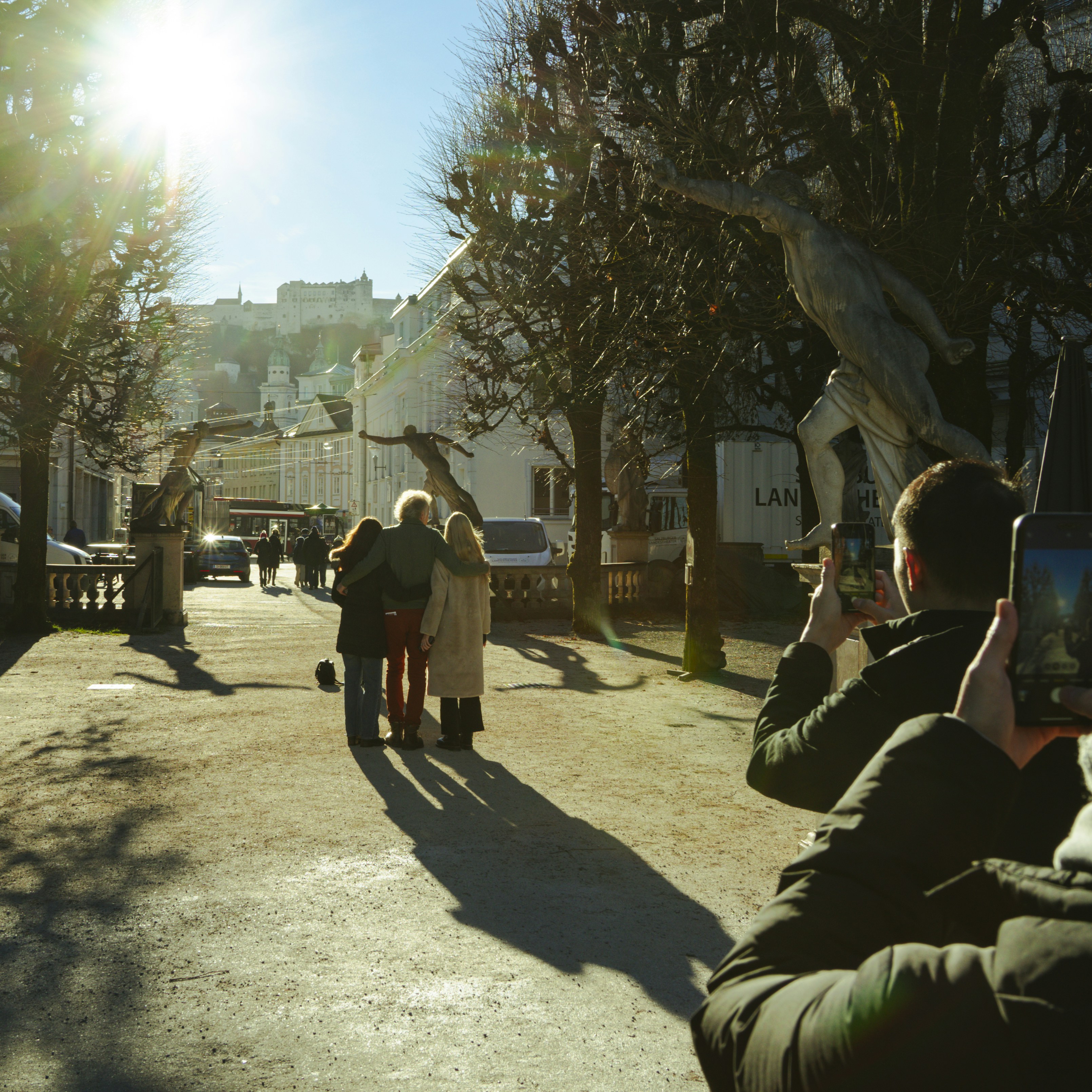 Sunlit Street Portrait: A Moment of Warmth Under a Cityscape Spotlight