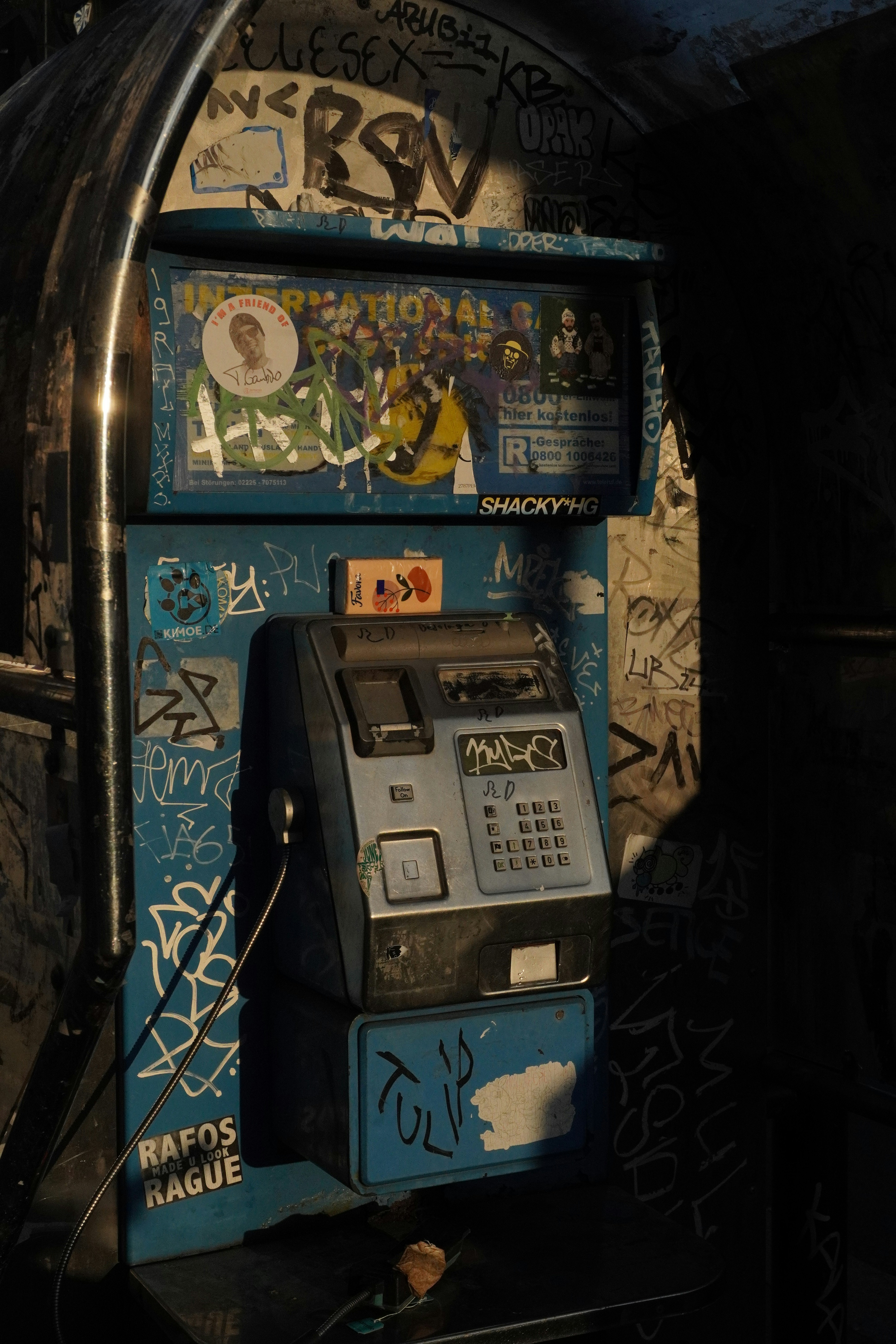 Graffiti-Graze: An Old ATM Beneath a Wall of Urban Echoes