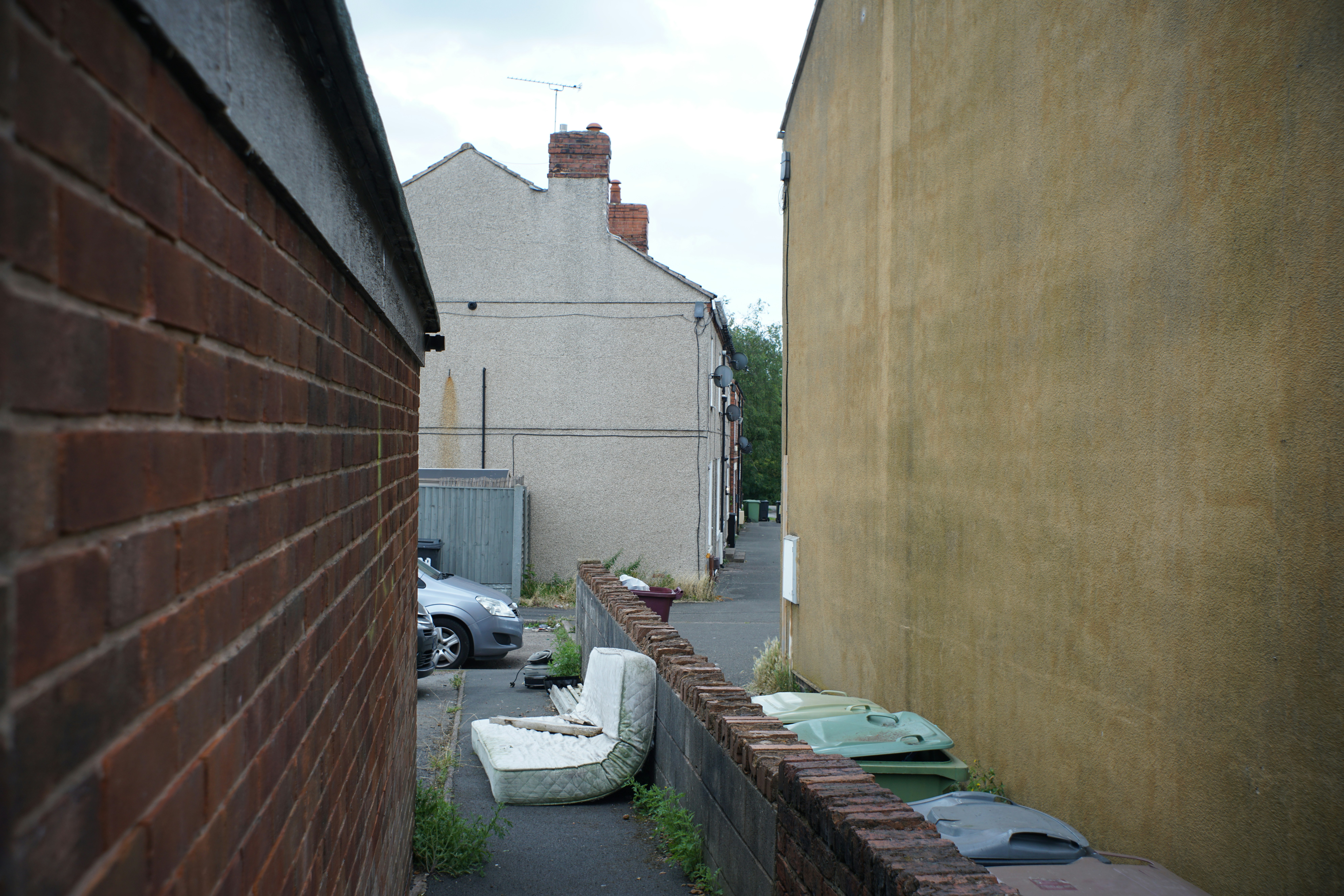 Narrow Alley Confluence: A Quiet Urban Transition Between Brick and Plaster