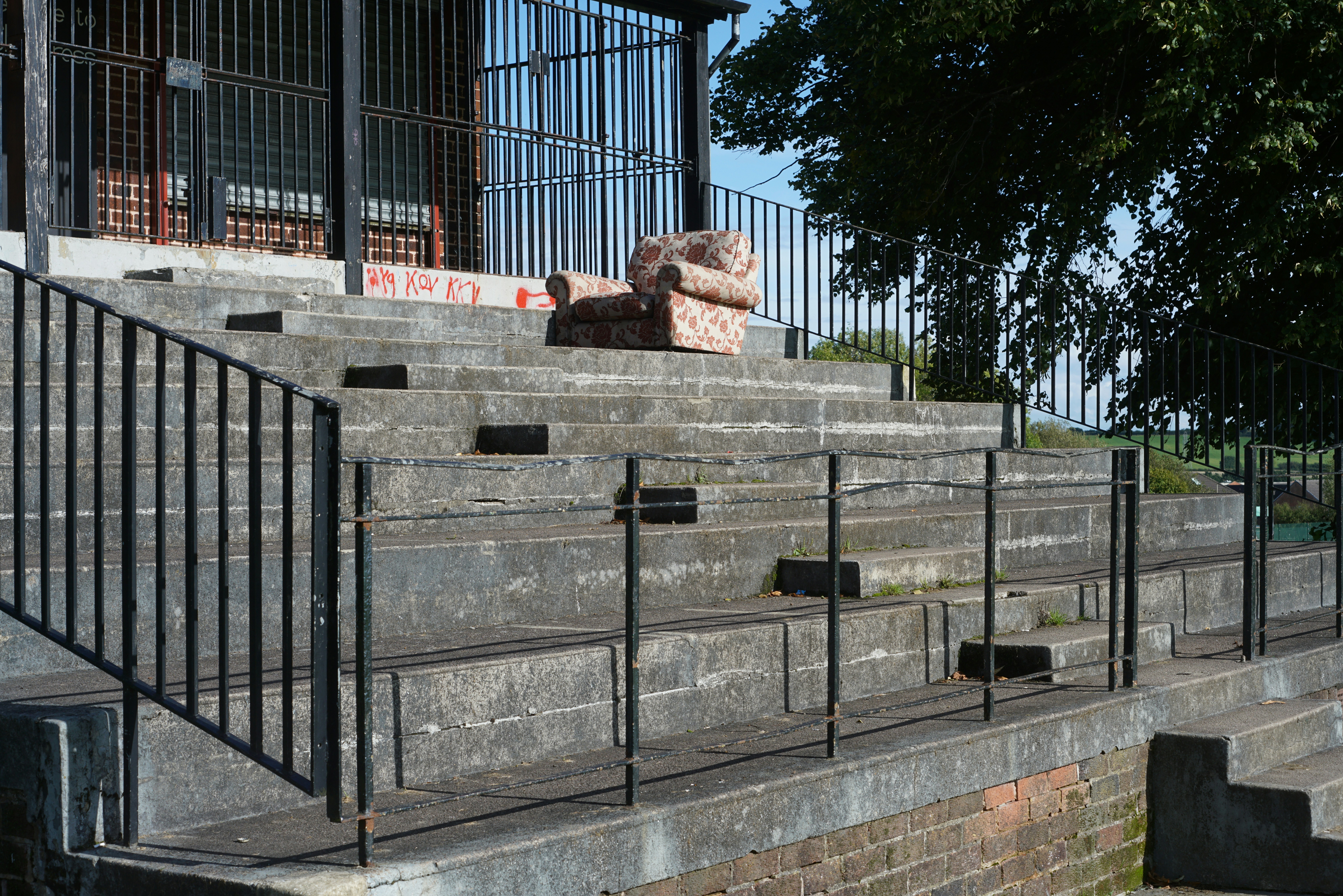 Abandoned Cushions on Stone Steps: A Quiet Urban Pause