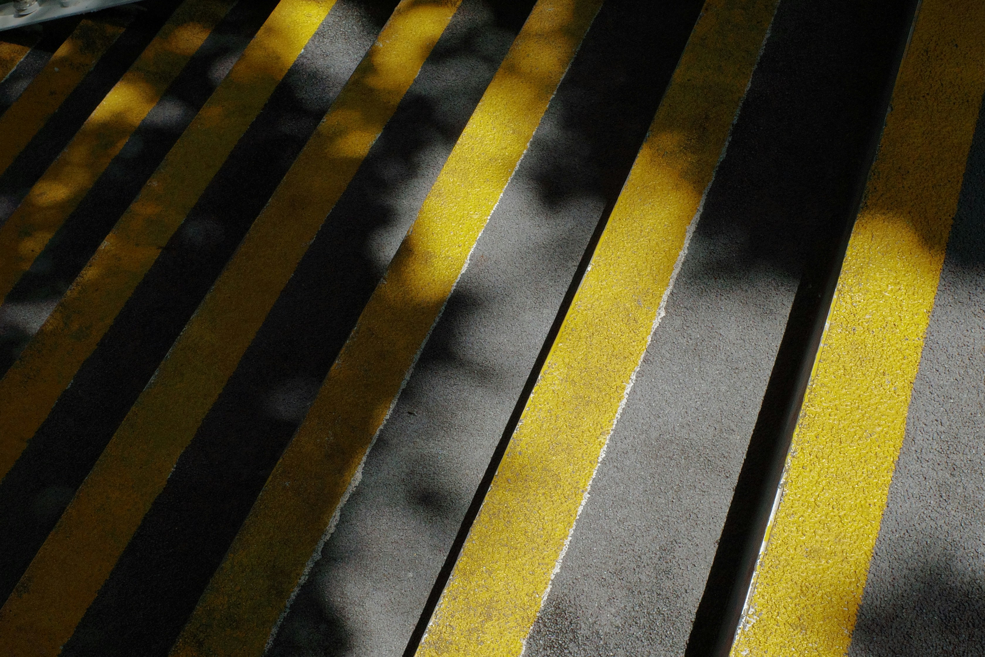 Banding Shadows and Yellow Stripes on Concrete Stairs