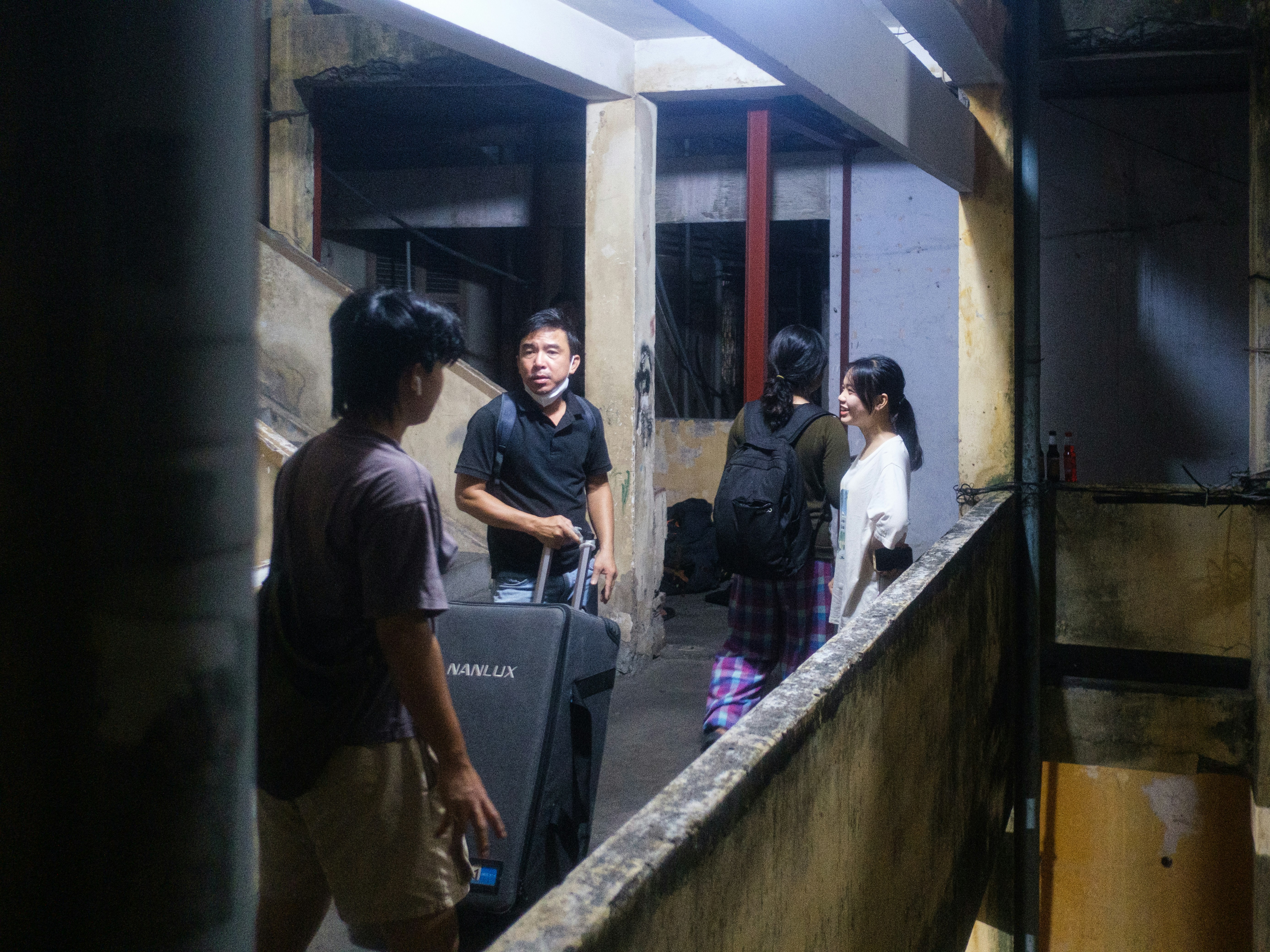 Nighttime Corridor Reunion: A Brief Pause in the Hallway
