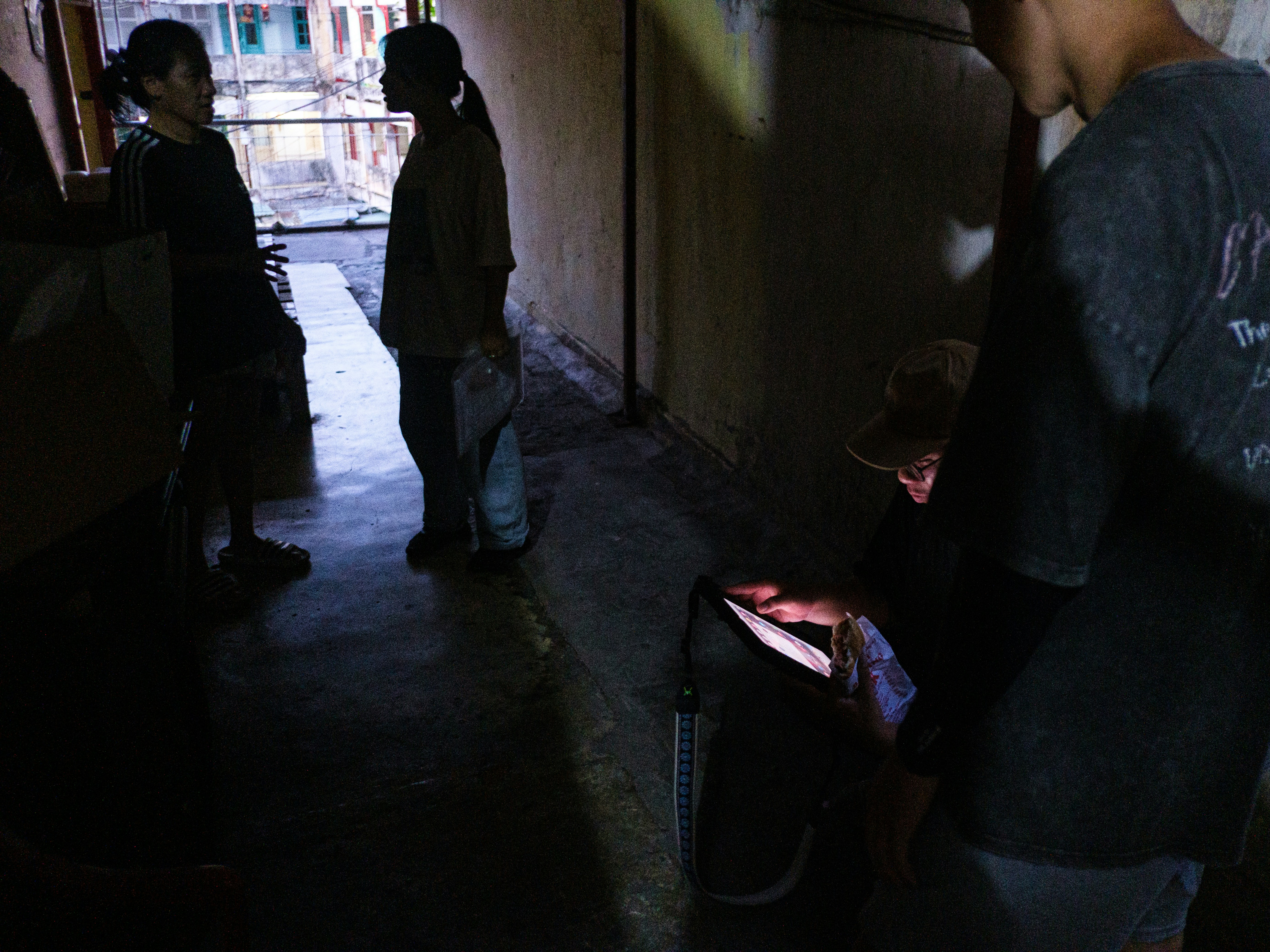 Backlit Corridor Portrait: Quiet Convergence in a Shadowed Frame