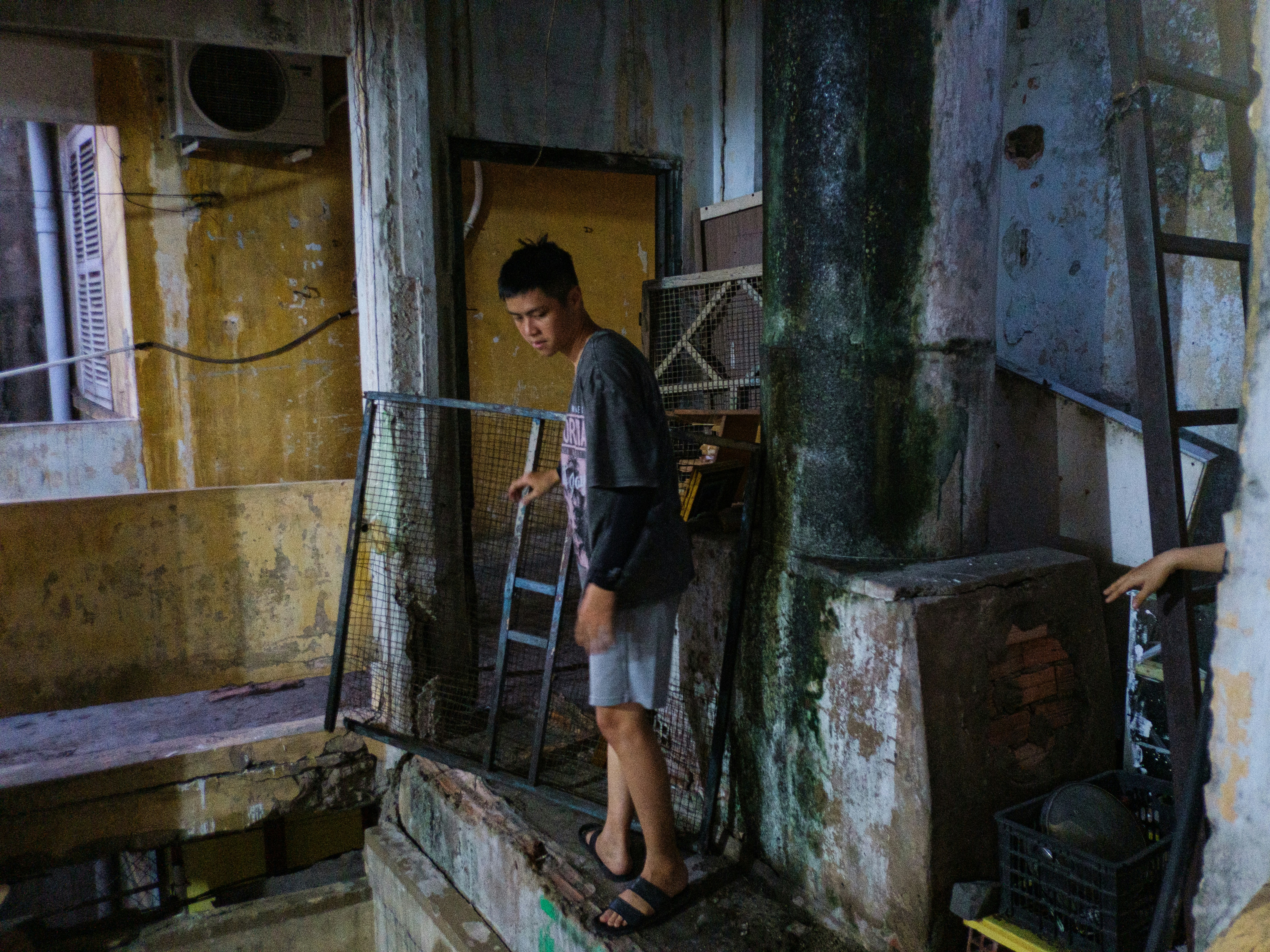 Muted Neon Decay: A Teen in the Threshold of a Deteriorating Courtyard