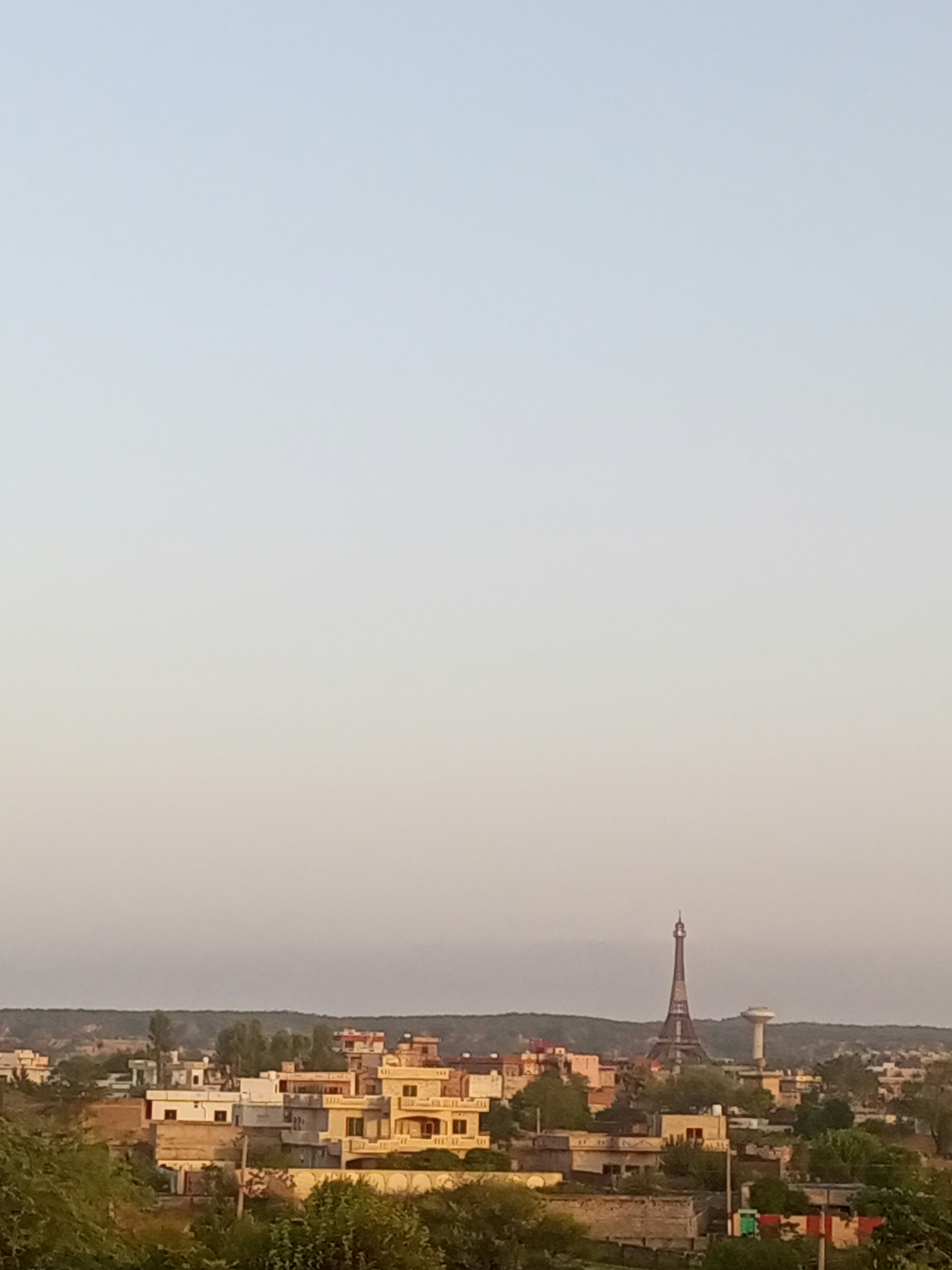 Distant Skyline: The Eiffel-like Tower Silhouette Over a Low Horizon