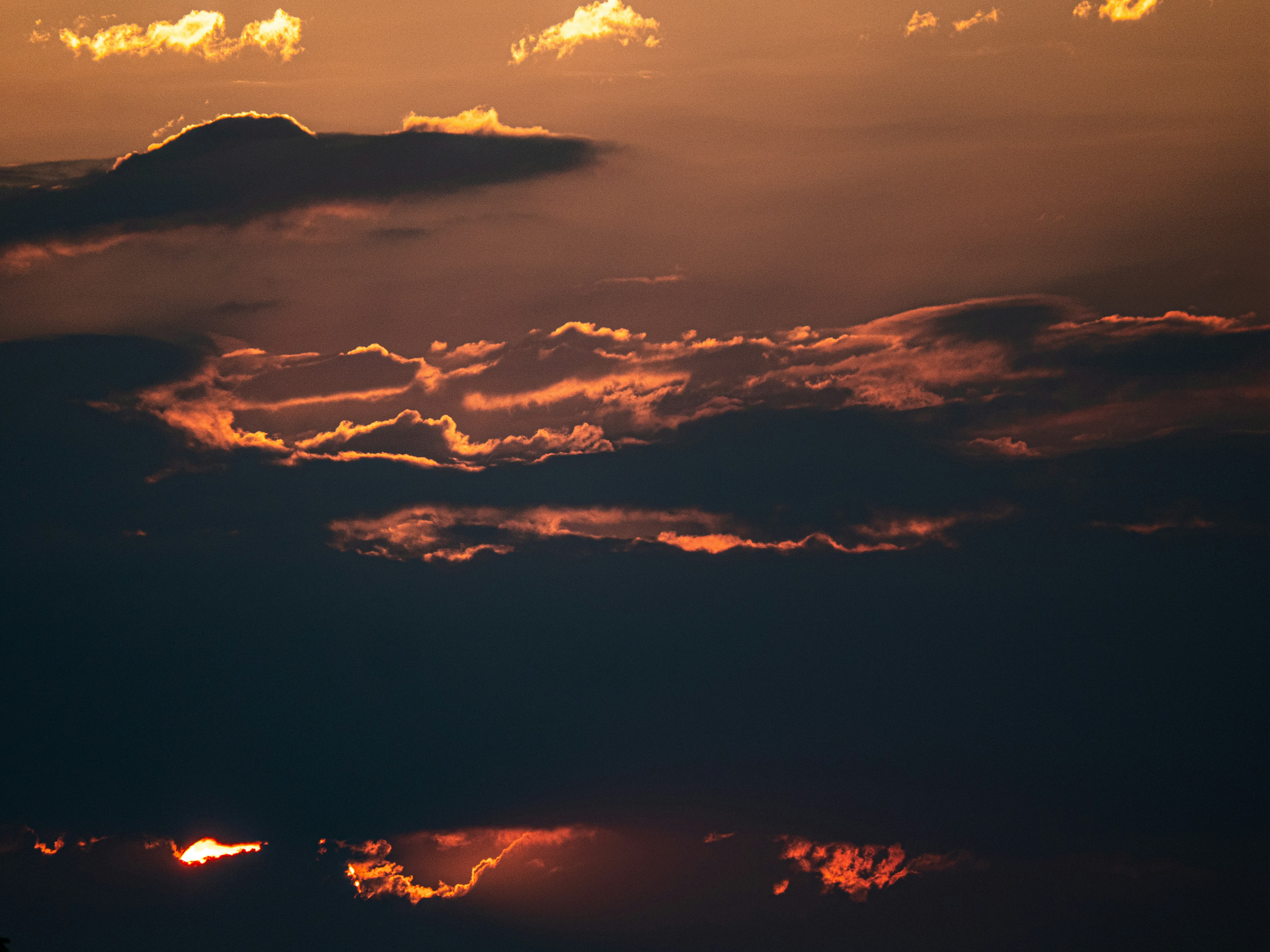 Sunset Veil: Quiet Horizon Over Dark Clouds
