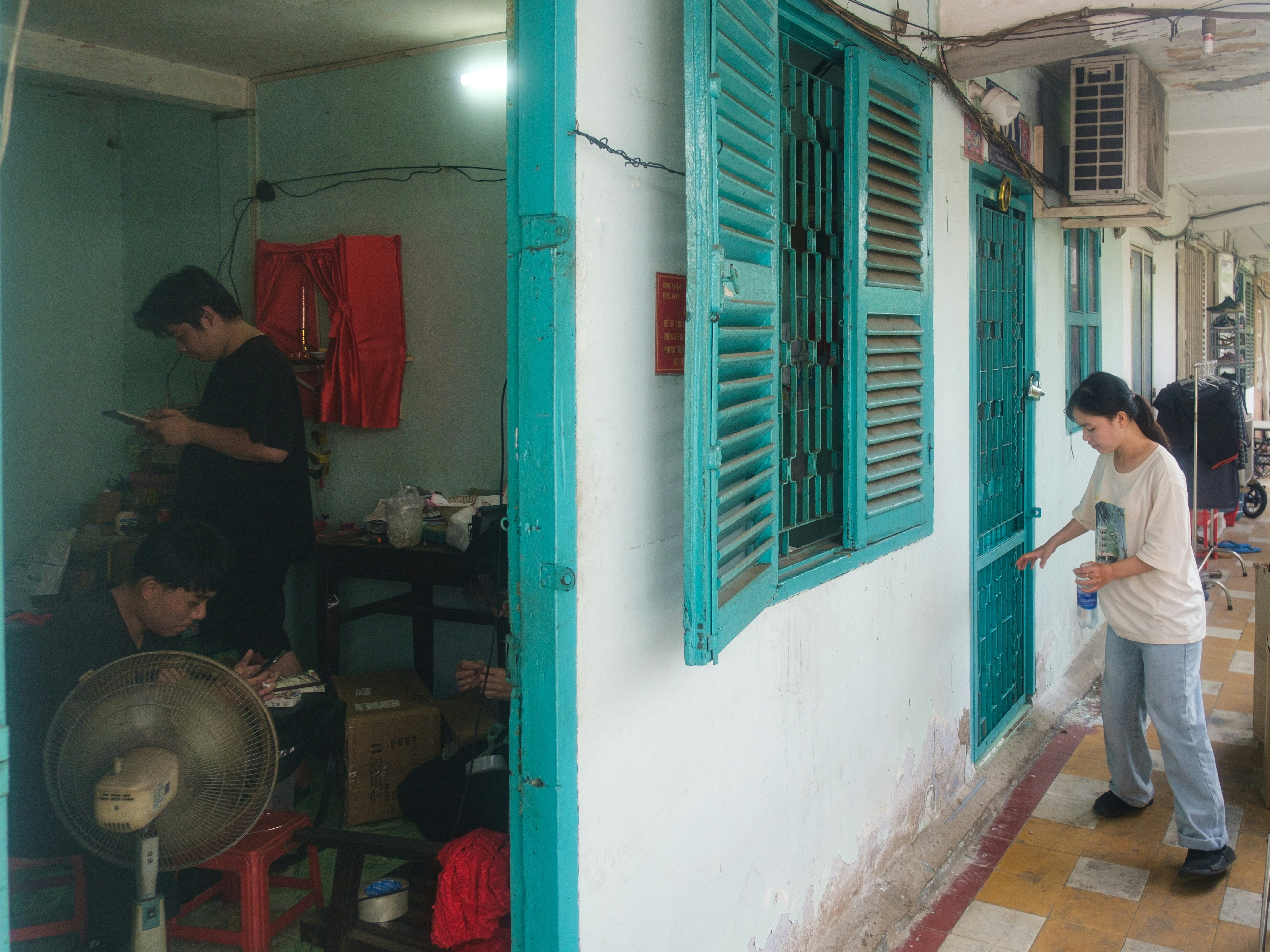 Turquoise shutters and quiet hallway cross paths