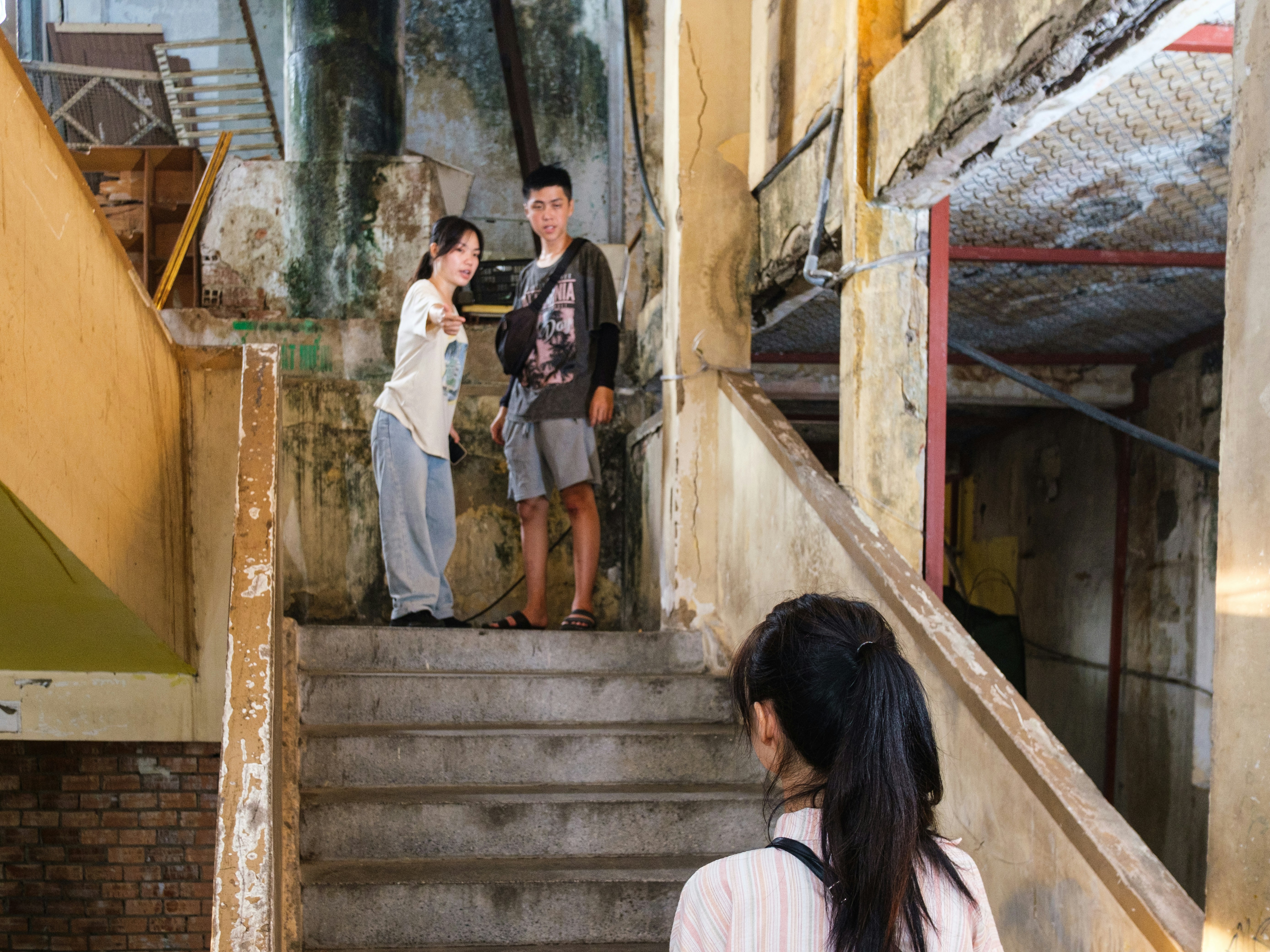 Stairwell Confrontation: A Moment of Silence Beneath Decay