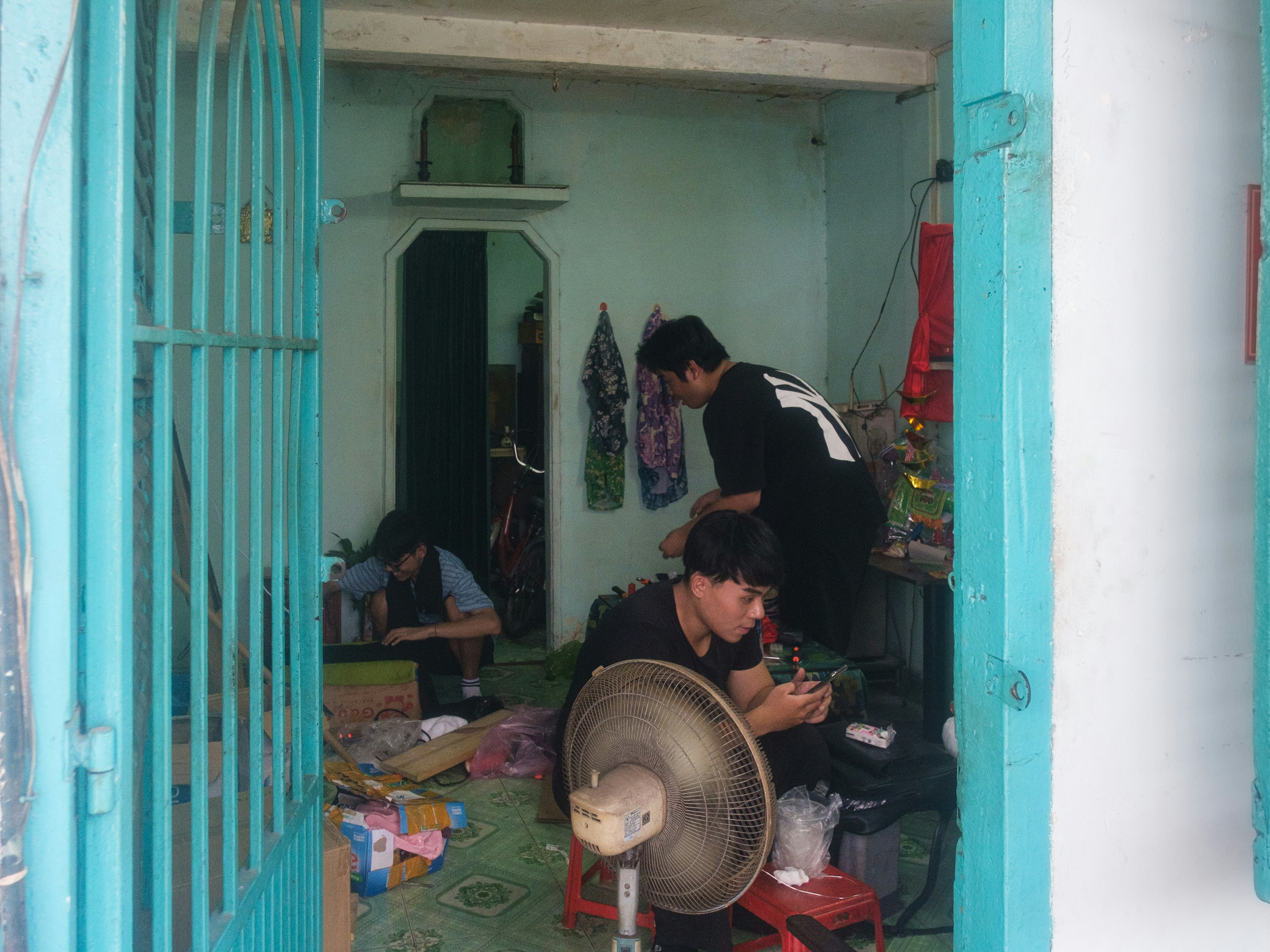 Inside a Humid Backroom: Friends, Fans, and Focused Moments