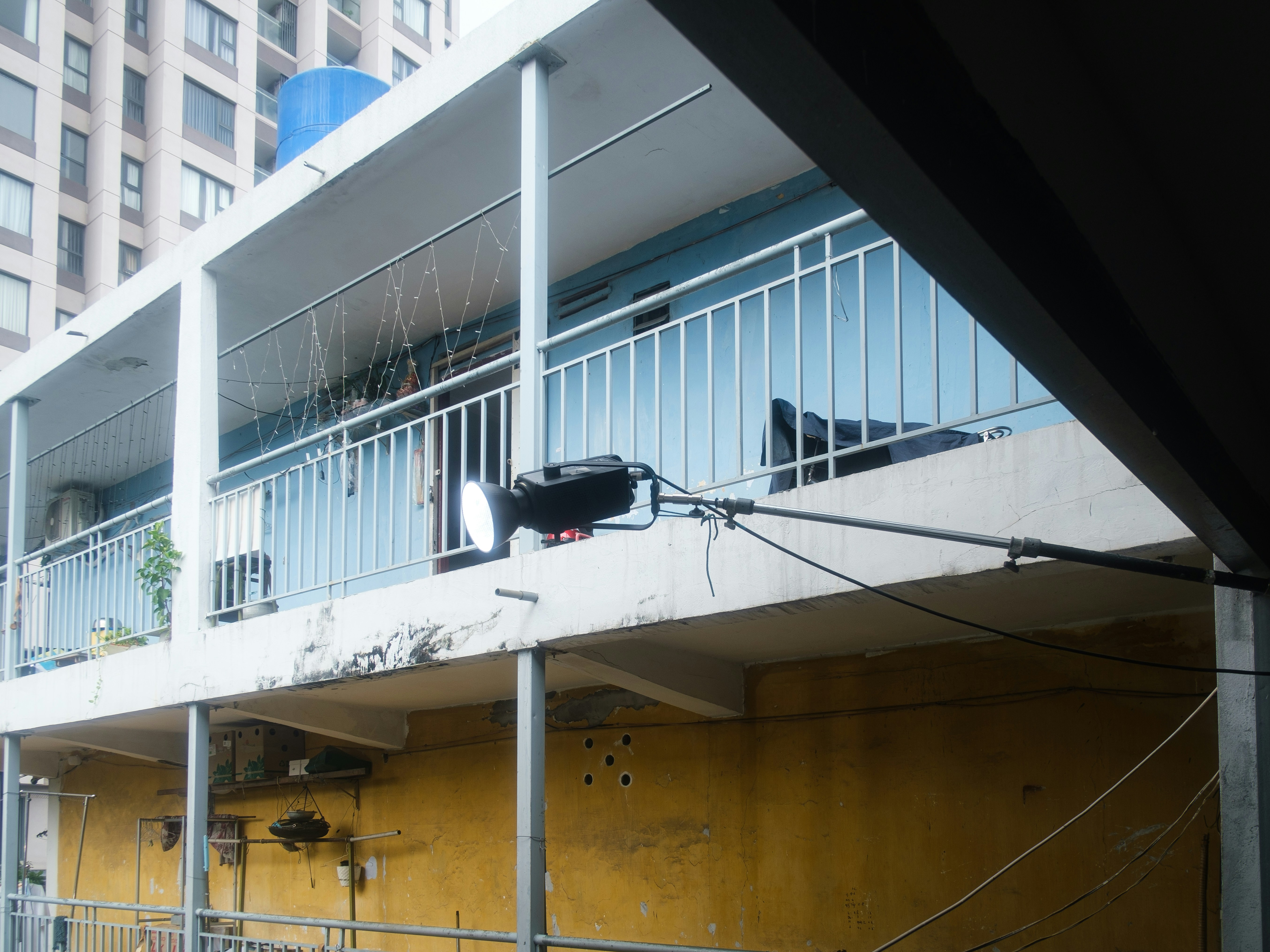 Overhead Light Rims the Balcony Edge