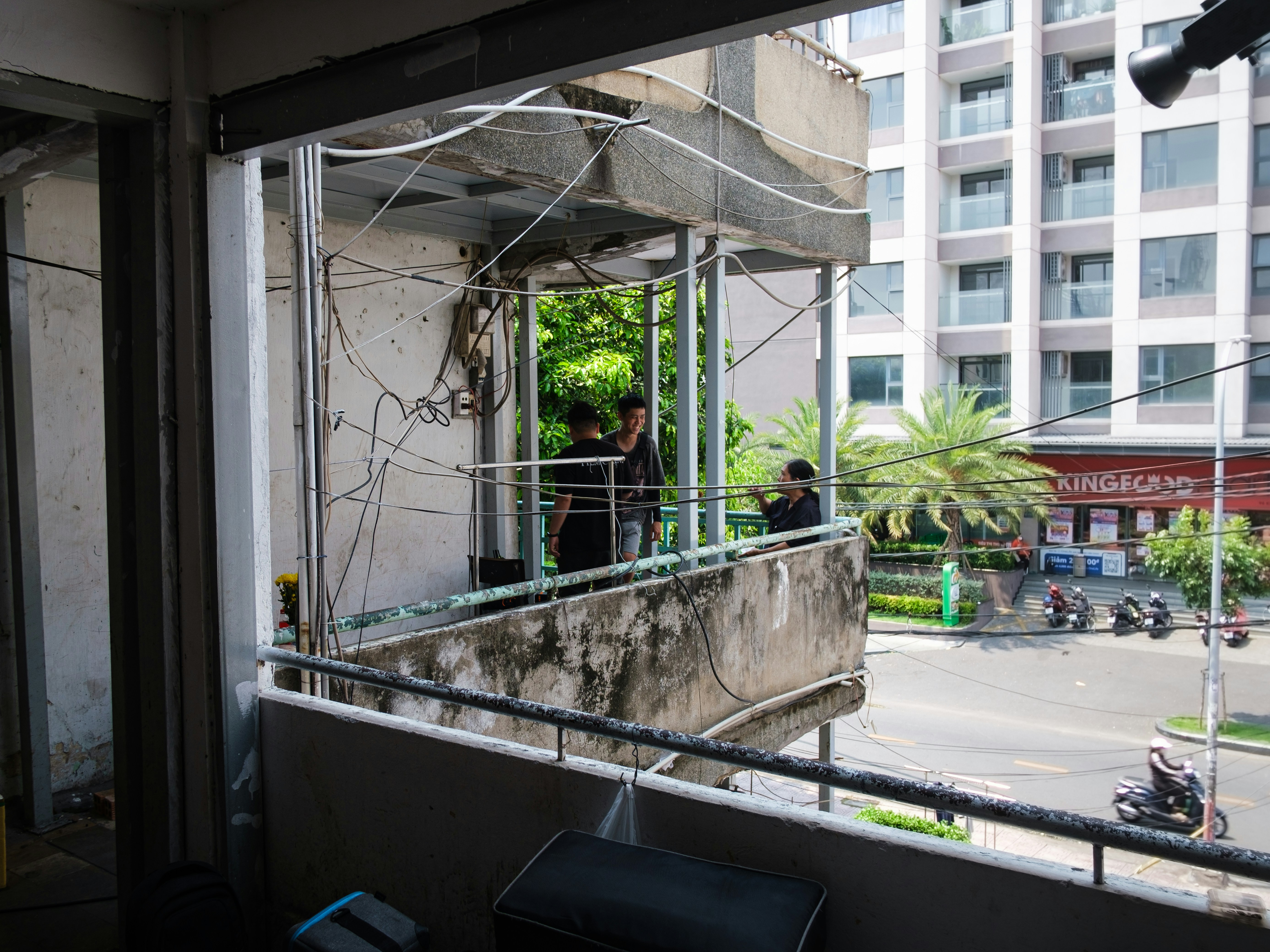 Concrete Balcony Rendezvous Above a Quiet Street