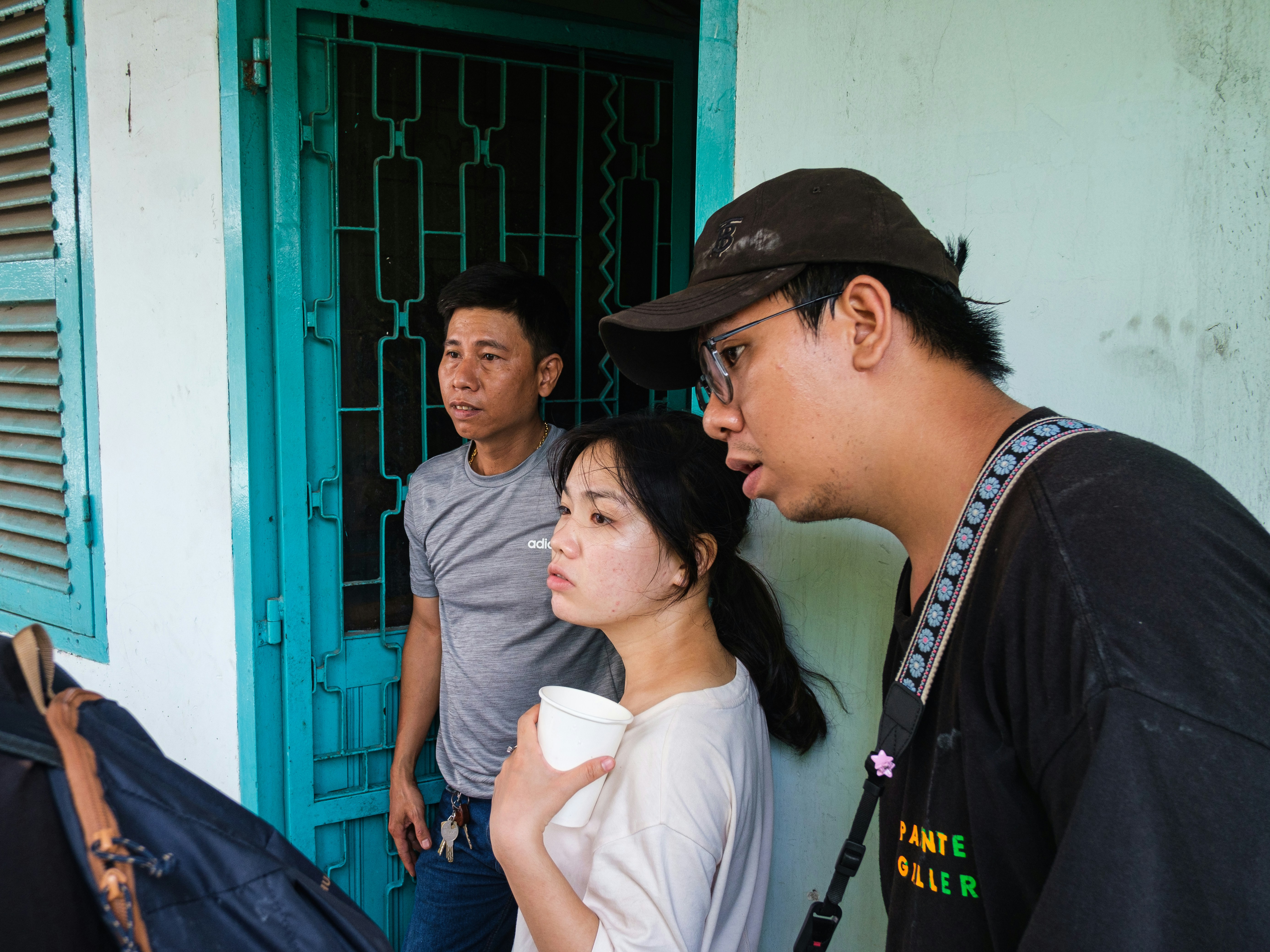 Intense Wait at the Doorway: A Trio in Focus
