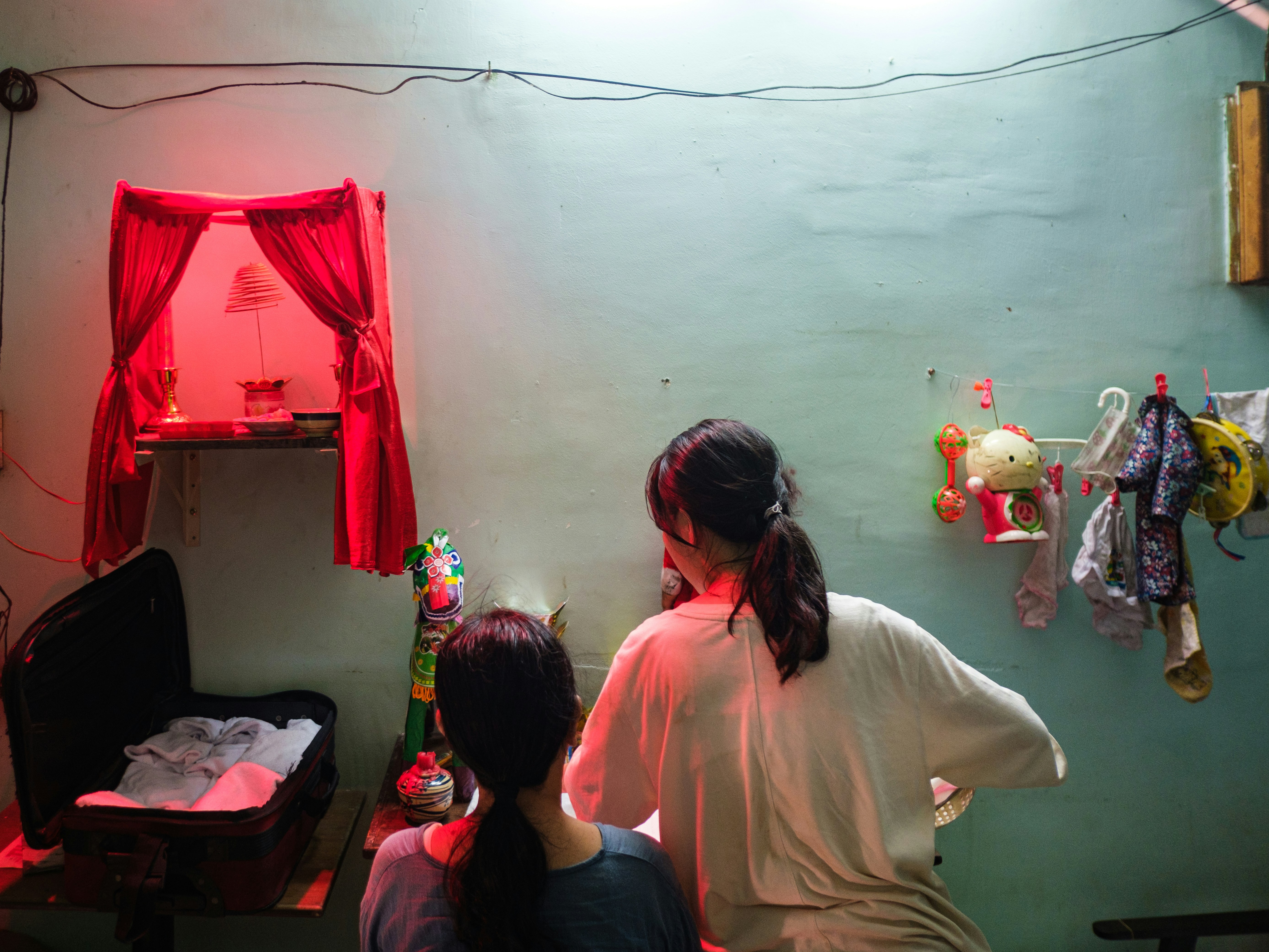 Mother and child in a softly lit nursery sharing a quiet moment