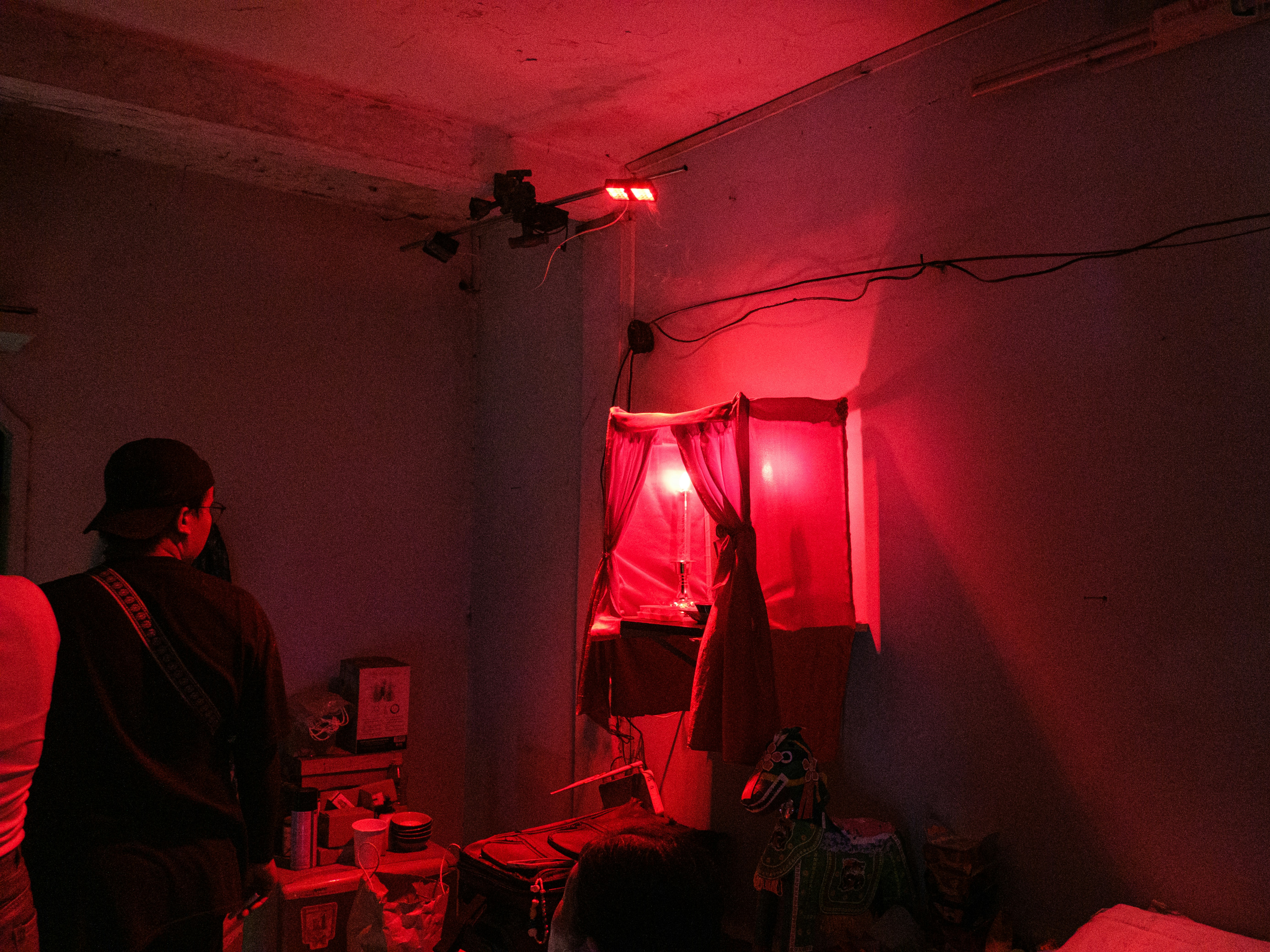 Red-lit Room with Shadowed Musician
