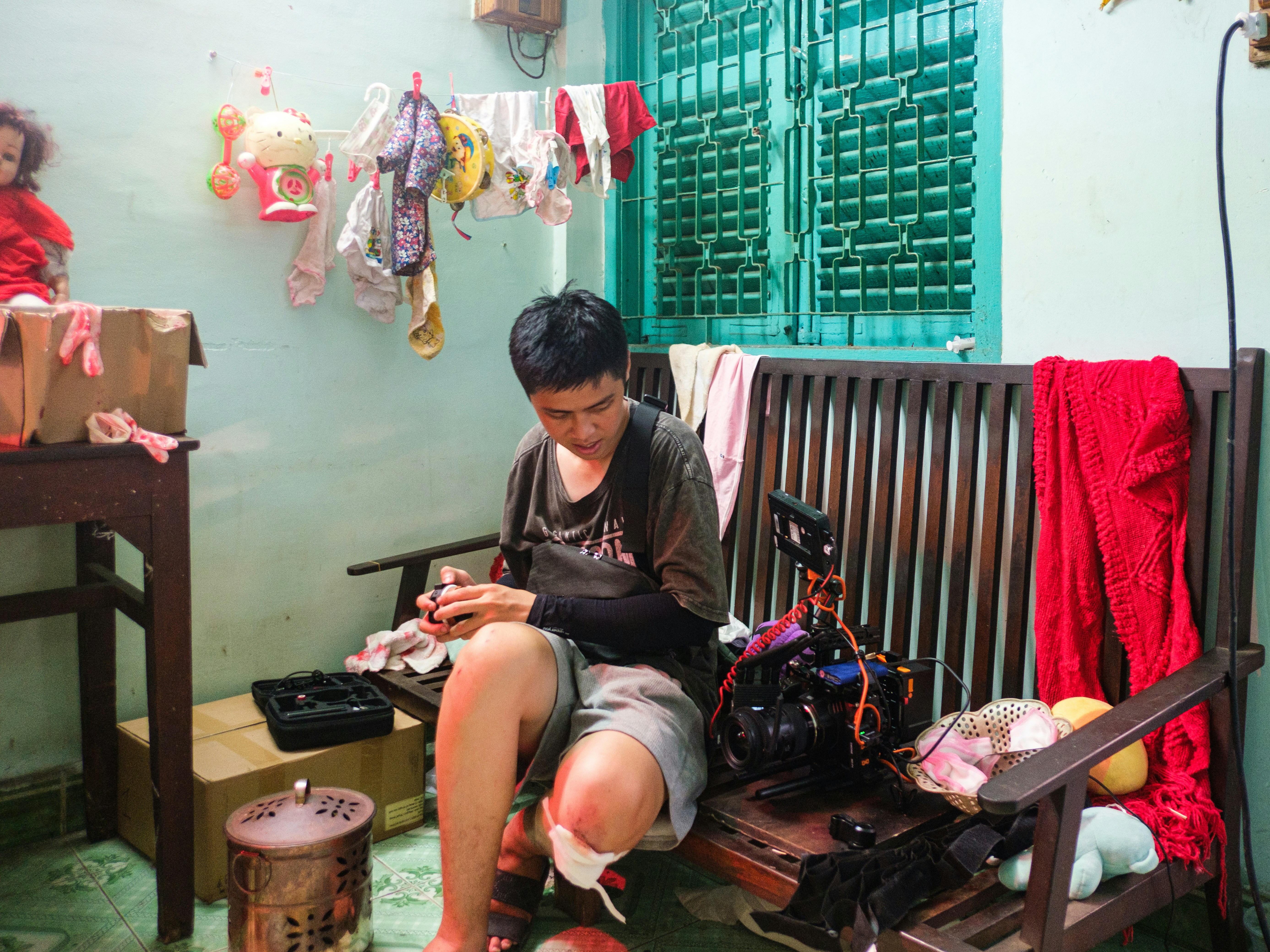 Child with a Camera: Quiet Moment in a Colorful Courtyard