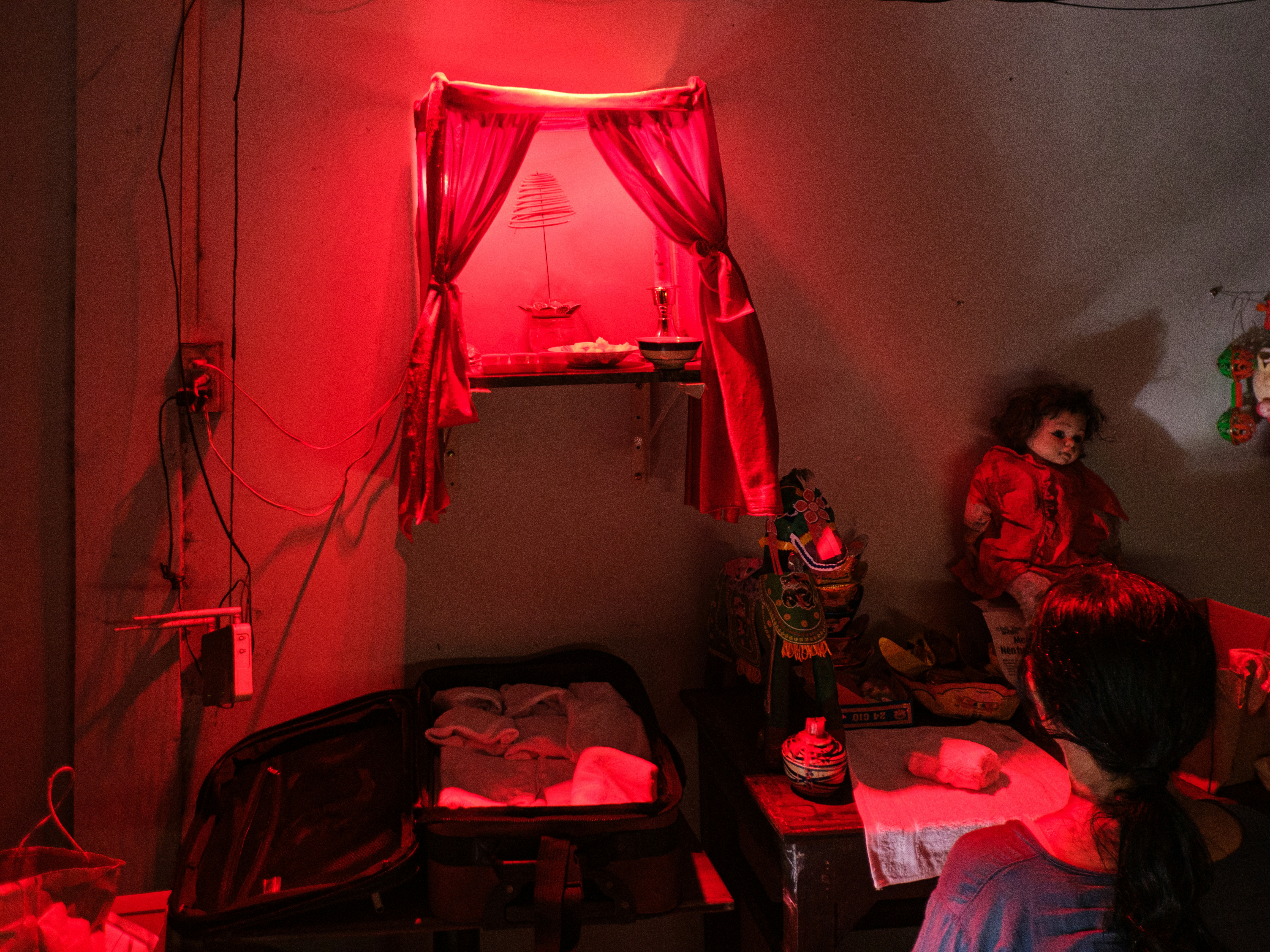 Red Room of Dolls: A Dim, Distant Glimpse into a Toy-filled Corner