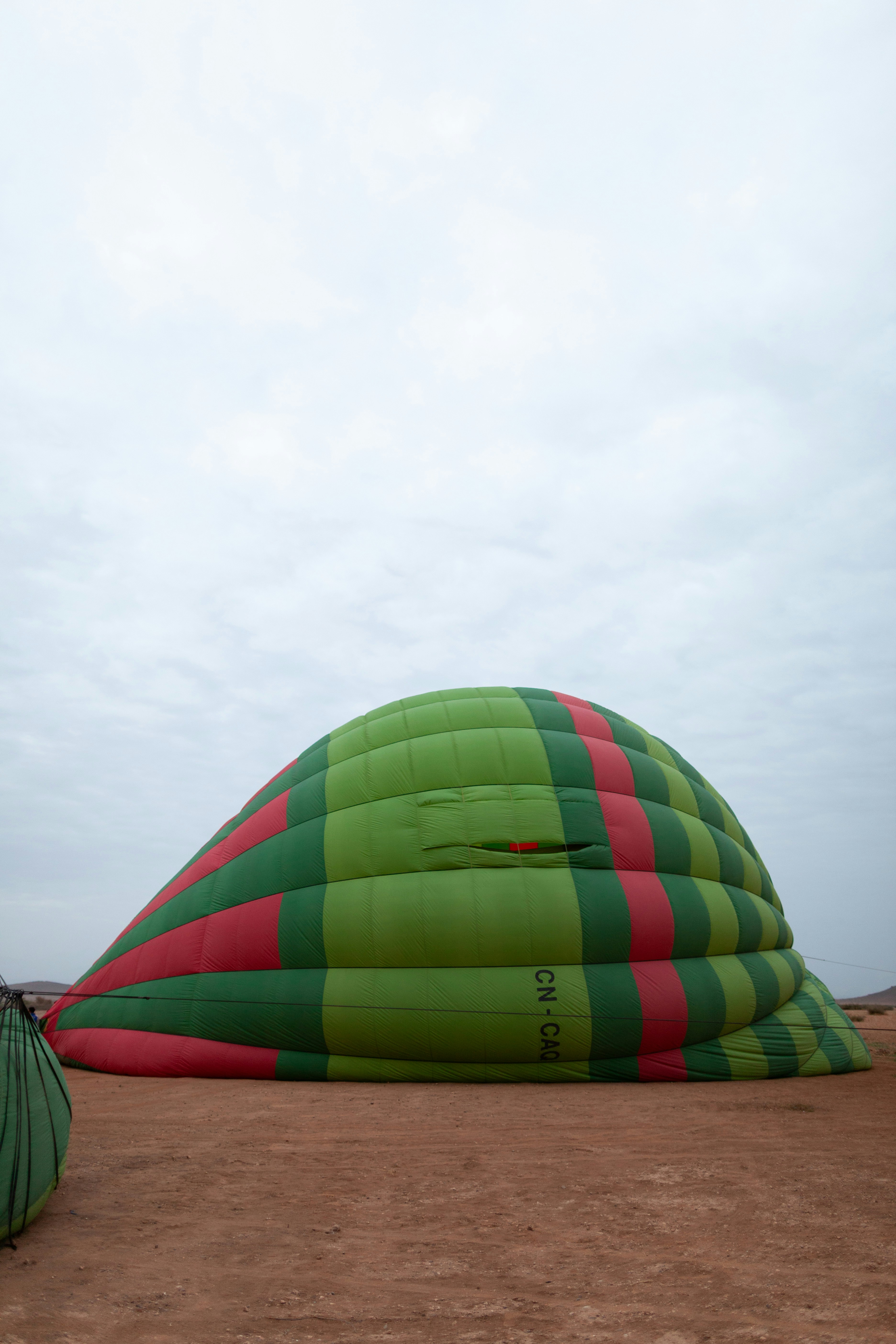 Airborne Colors: Green-Red Capsule Waiting on a Dusty Plain
