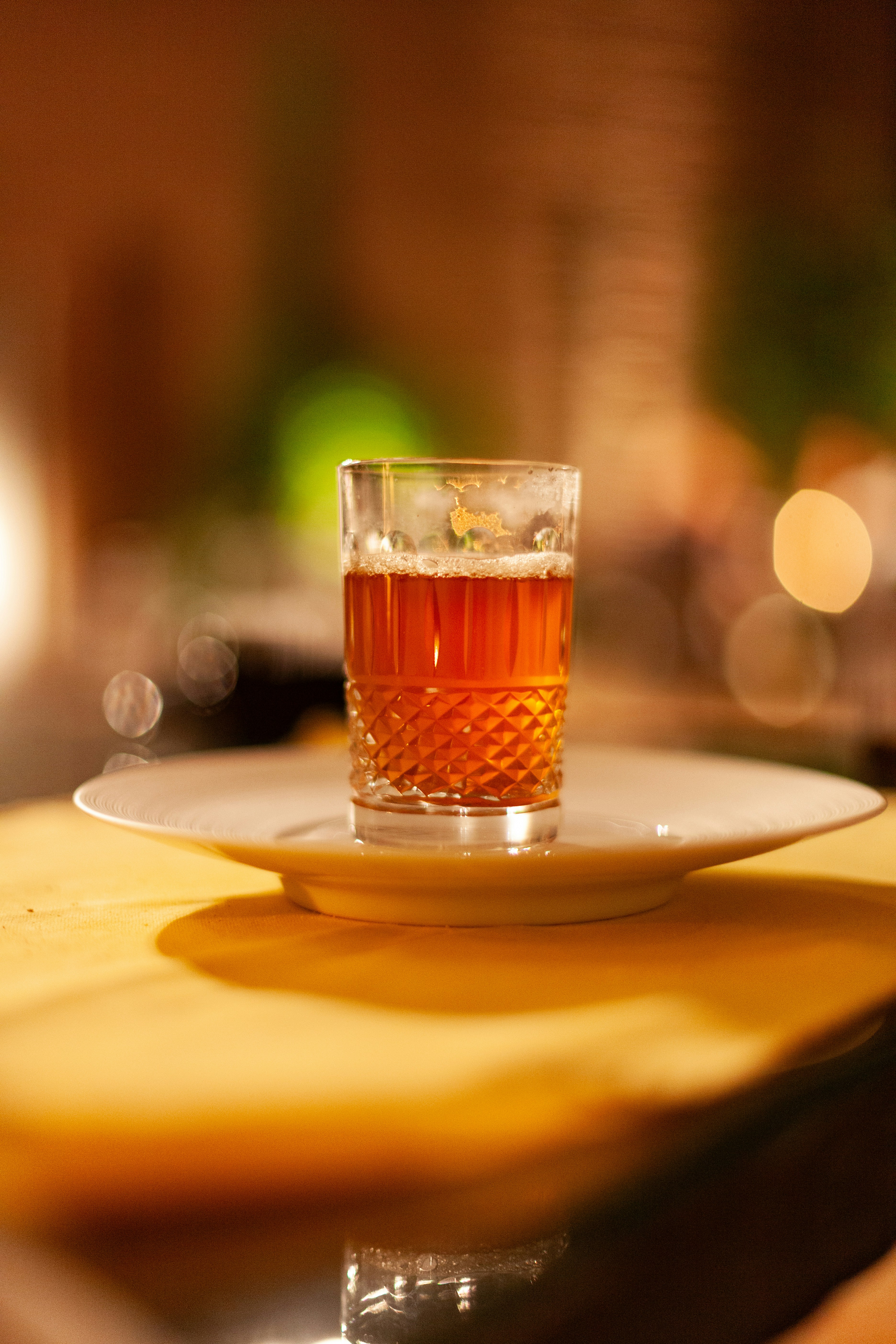 Amber Glass on a Quiet Plate: A Nightcap in Soft Focus