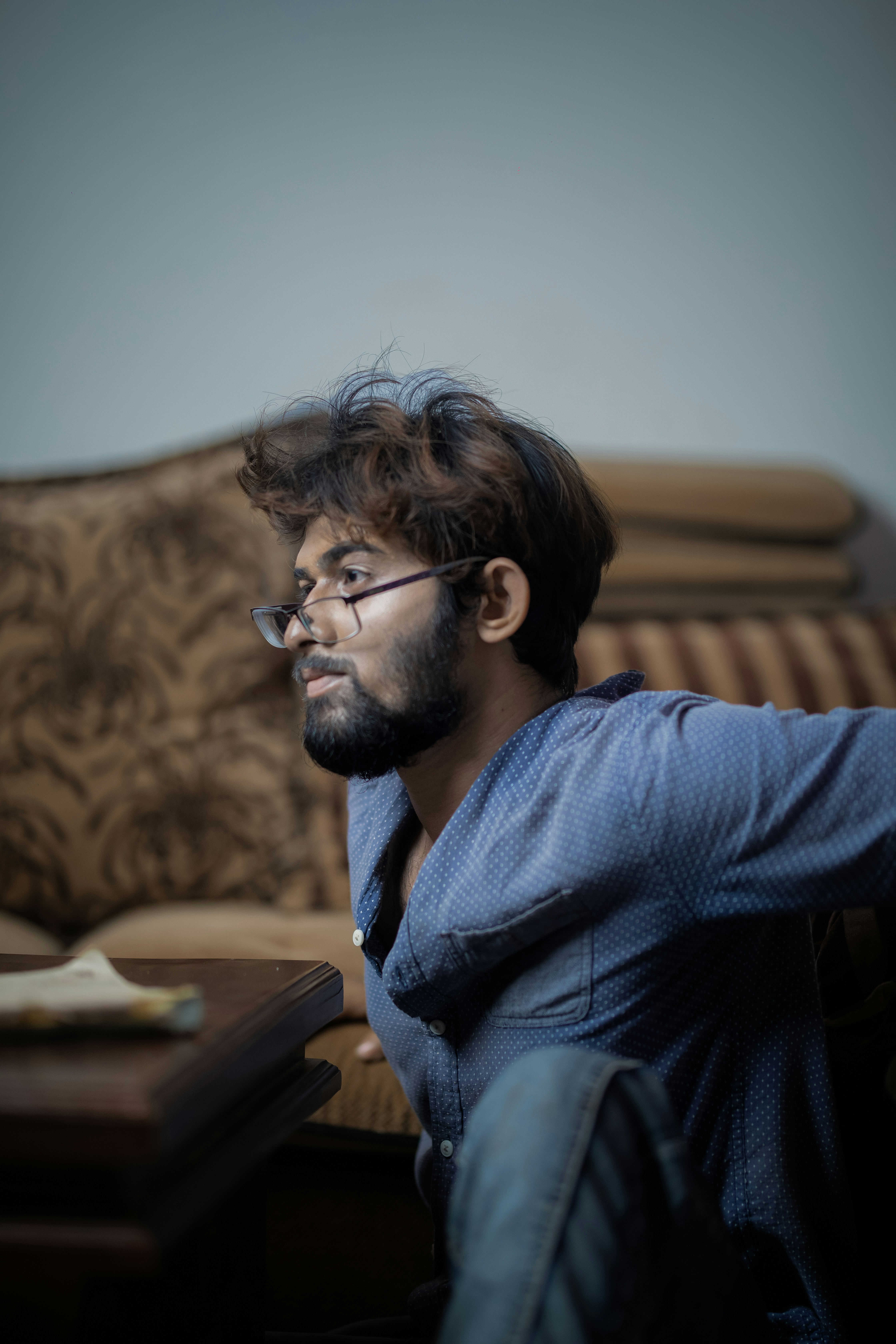 Focused Gaze in Quiet Study: A Casual Portrait in Warm Studio Light
