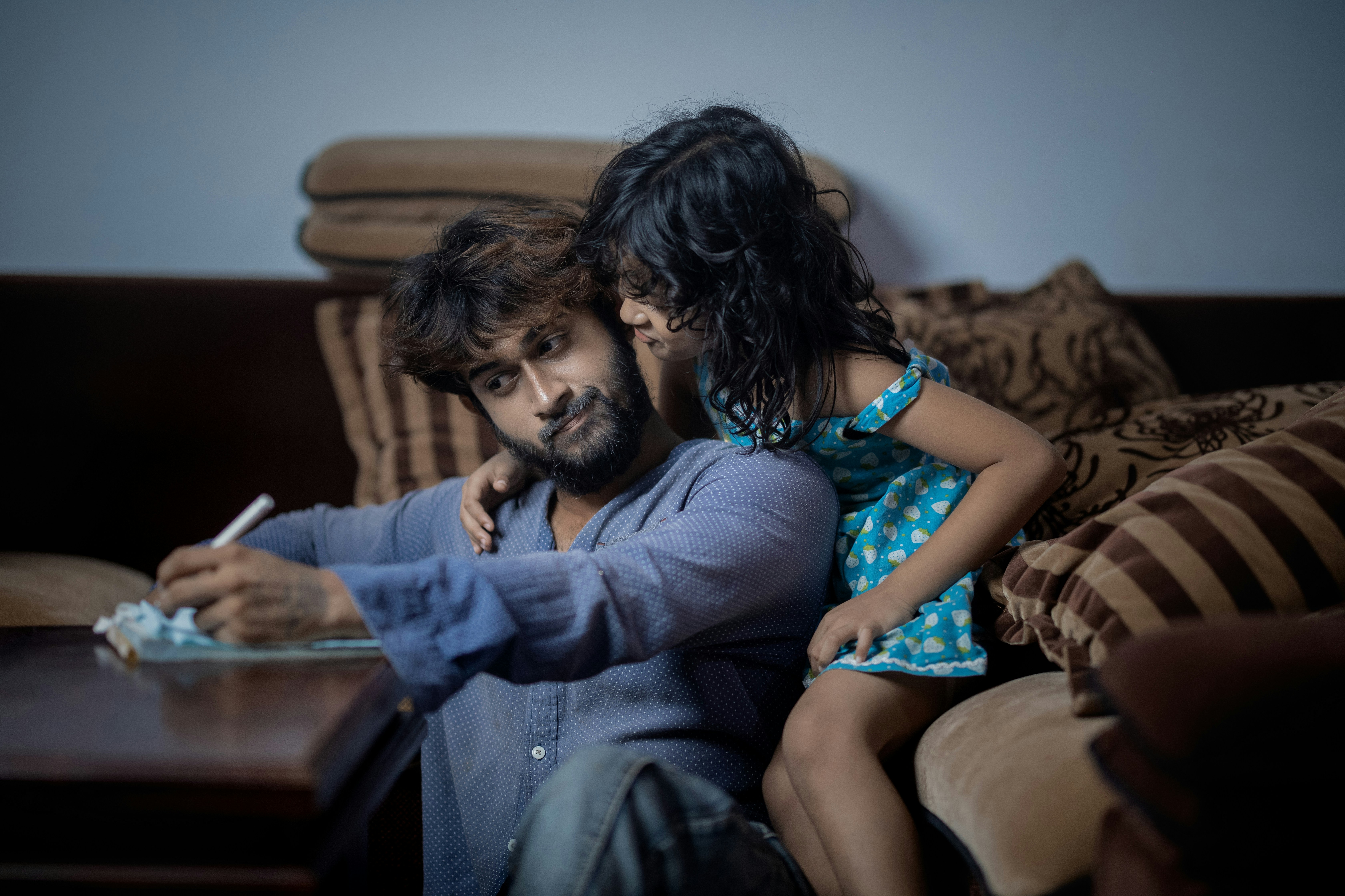 A Quiet Moment: Father and Daughter at the Couch
