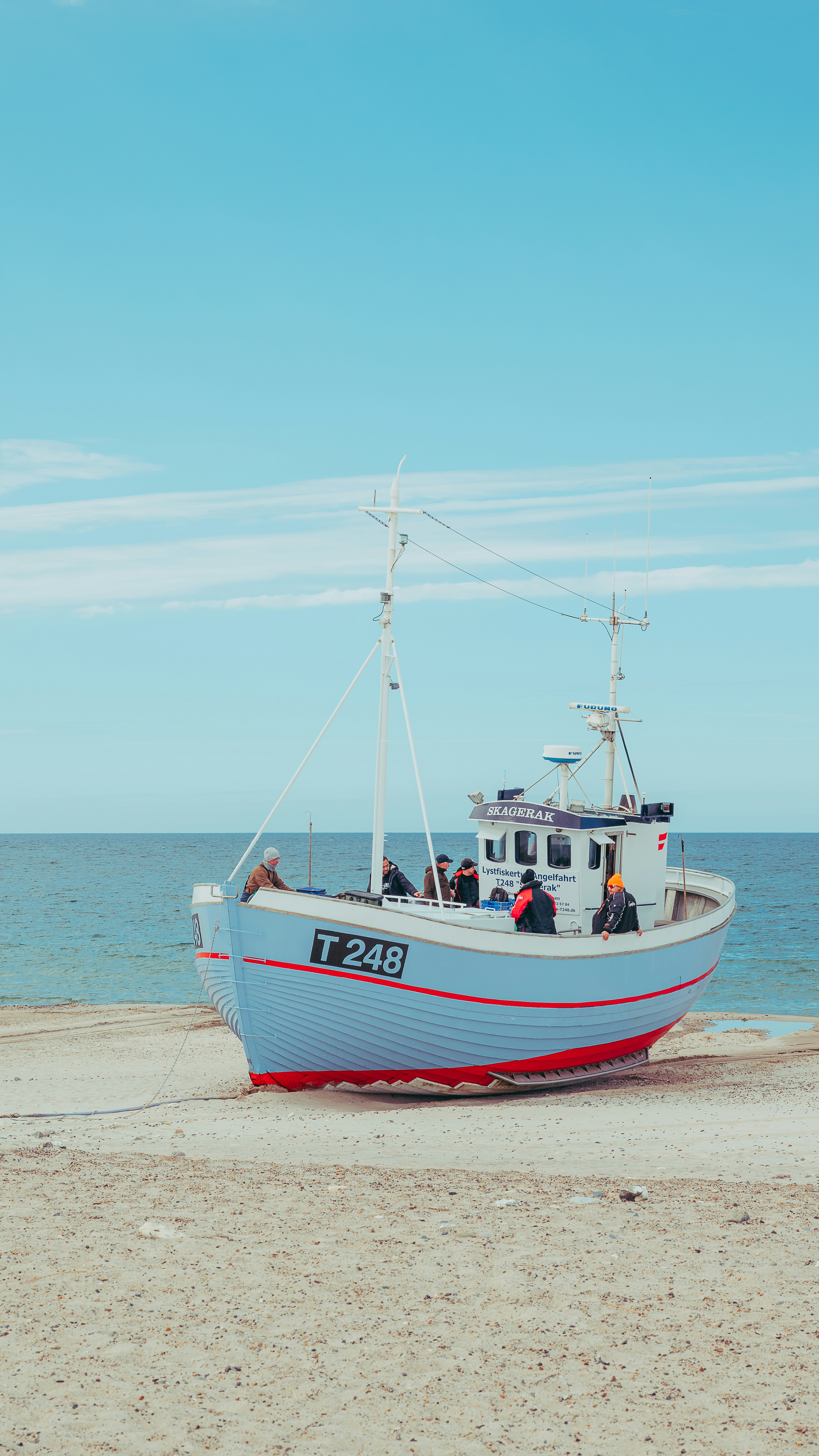 Docked at the Quiet Shore: The Fishing Boat and its Crew